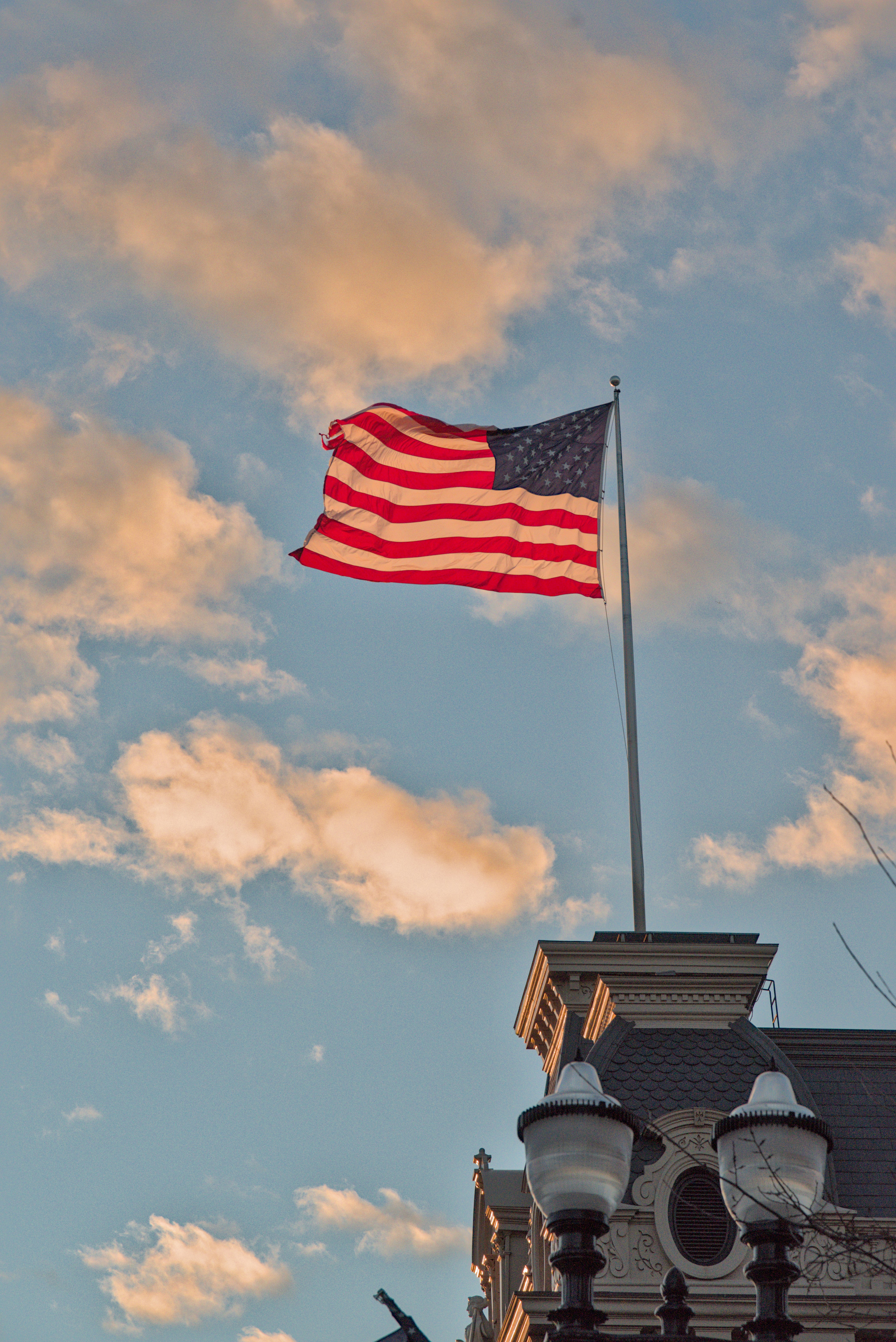 Star-Spangled Above the Gilded Rooftop: A Flag Waving Over Historic Facade