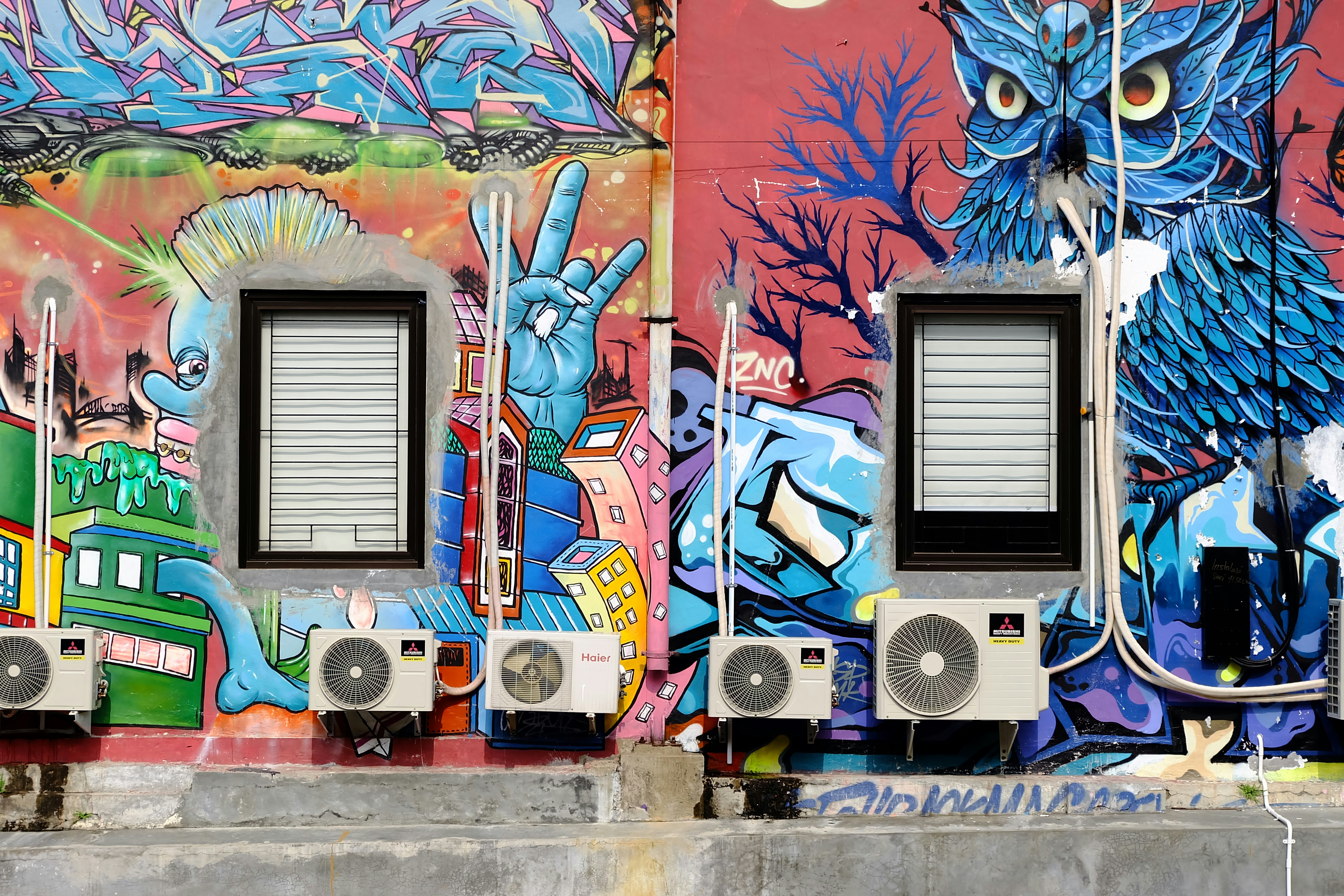 Peace Sign Rising Between Neon Graffiti and a Row of AC Units