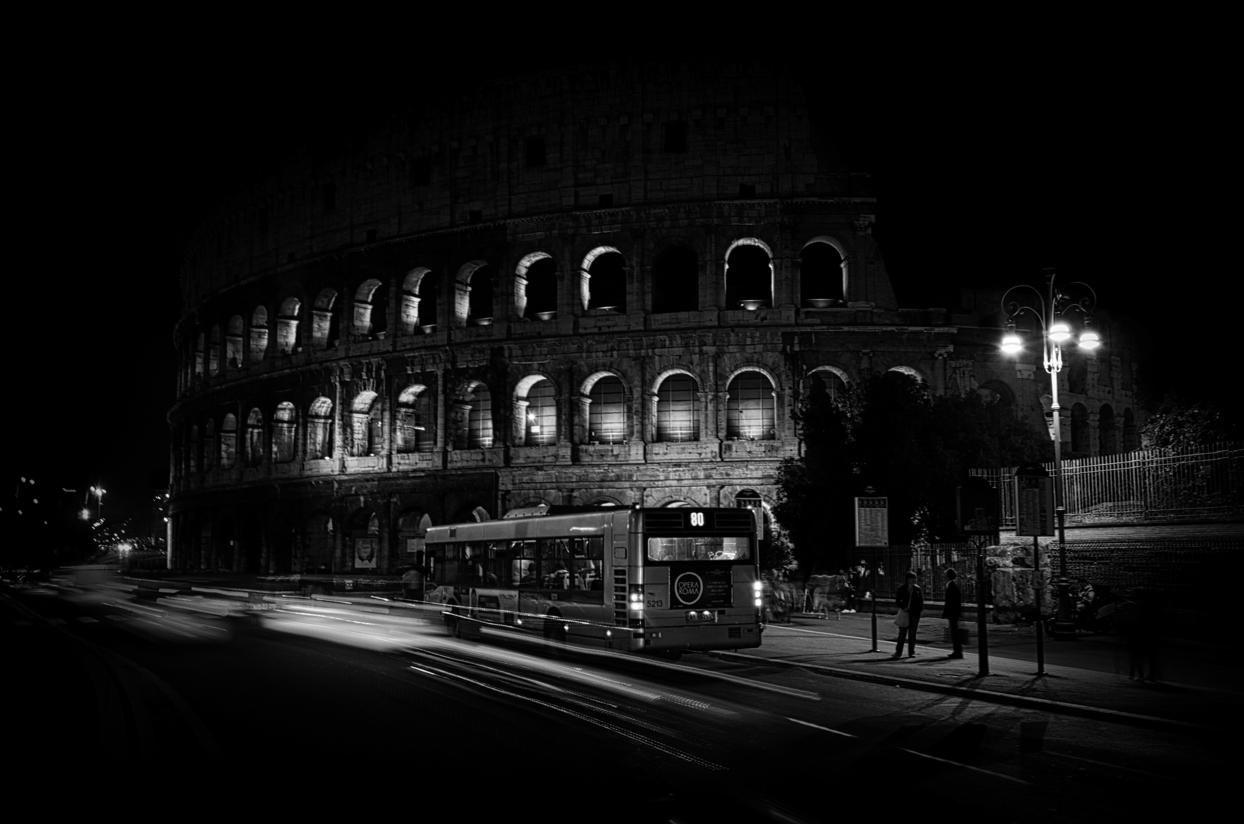 Arches at Night: Light Trails by Rome's Colosseum
