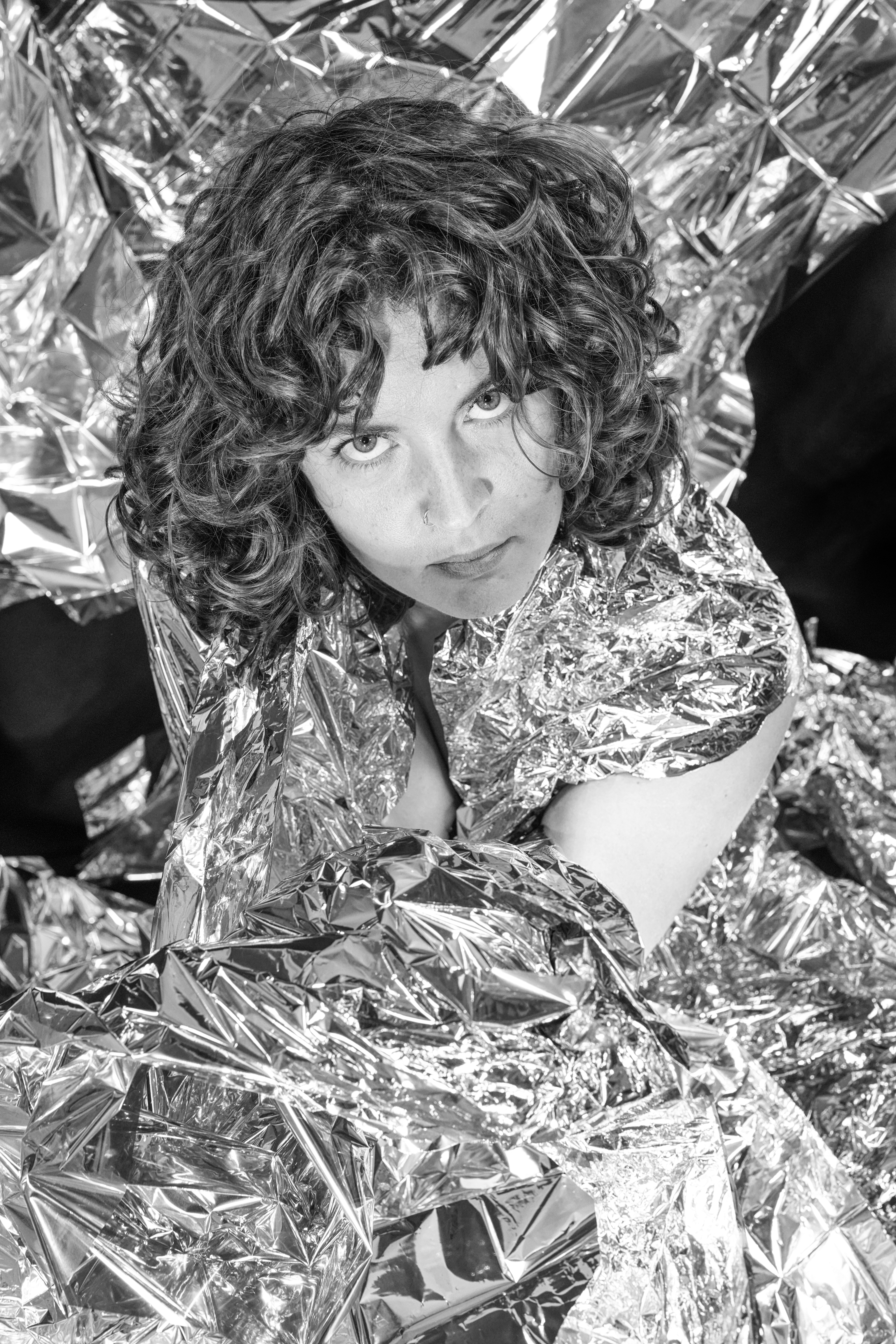 Woman wrapped in shiny metallic material