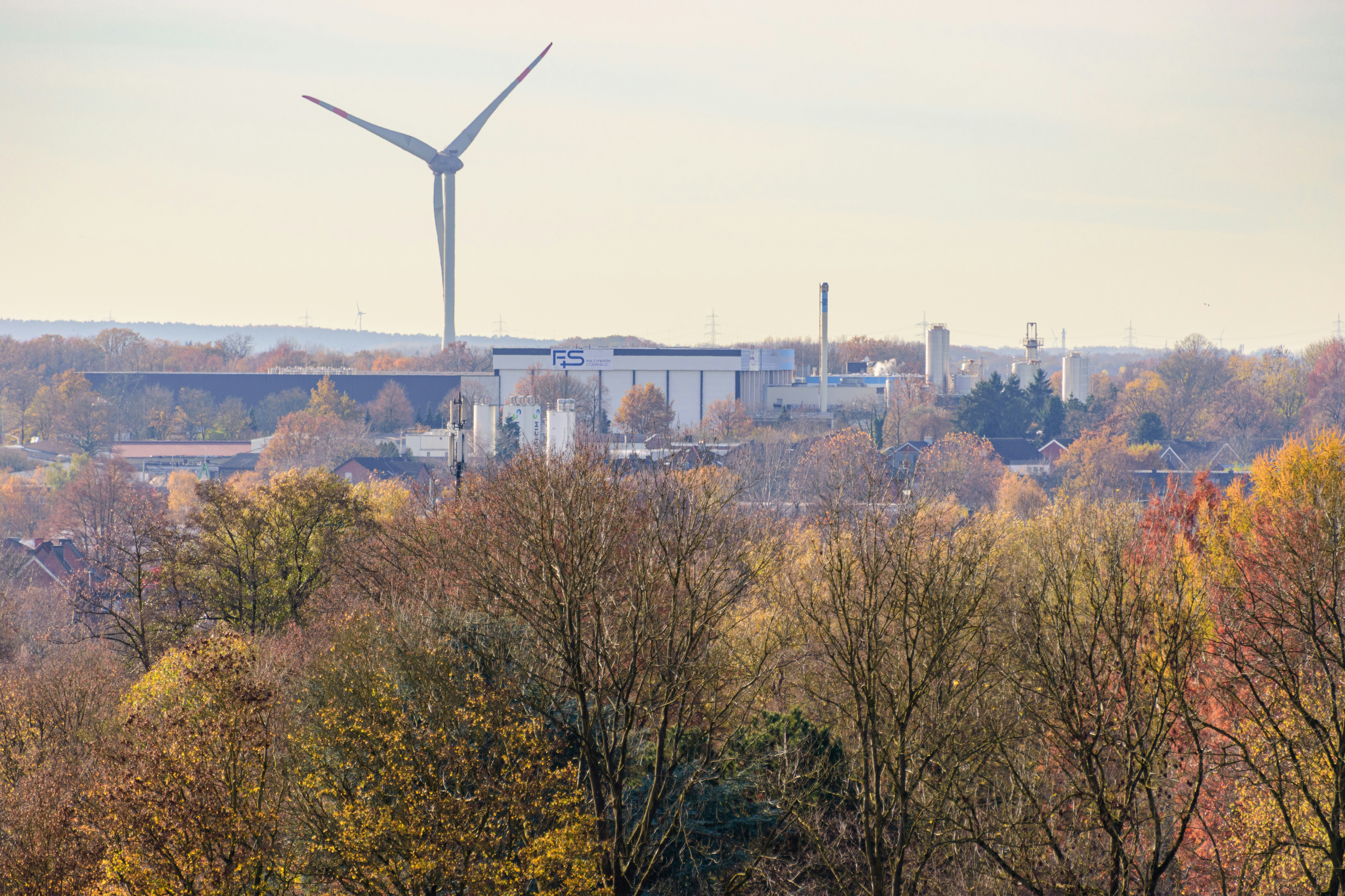 Autumn's Edge: A Wind Turbine Framing the Industrial Horizon