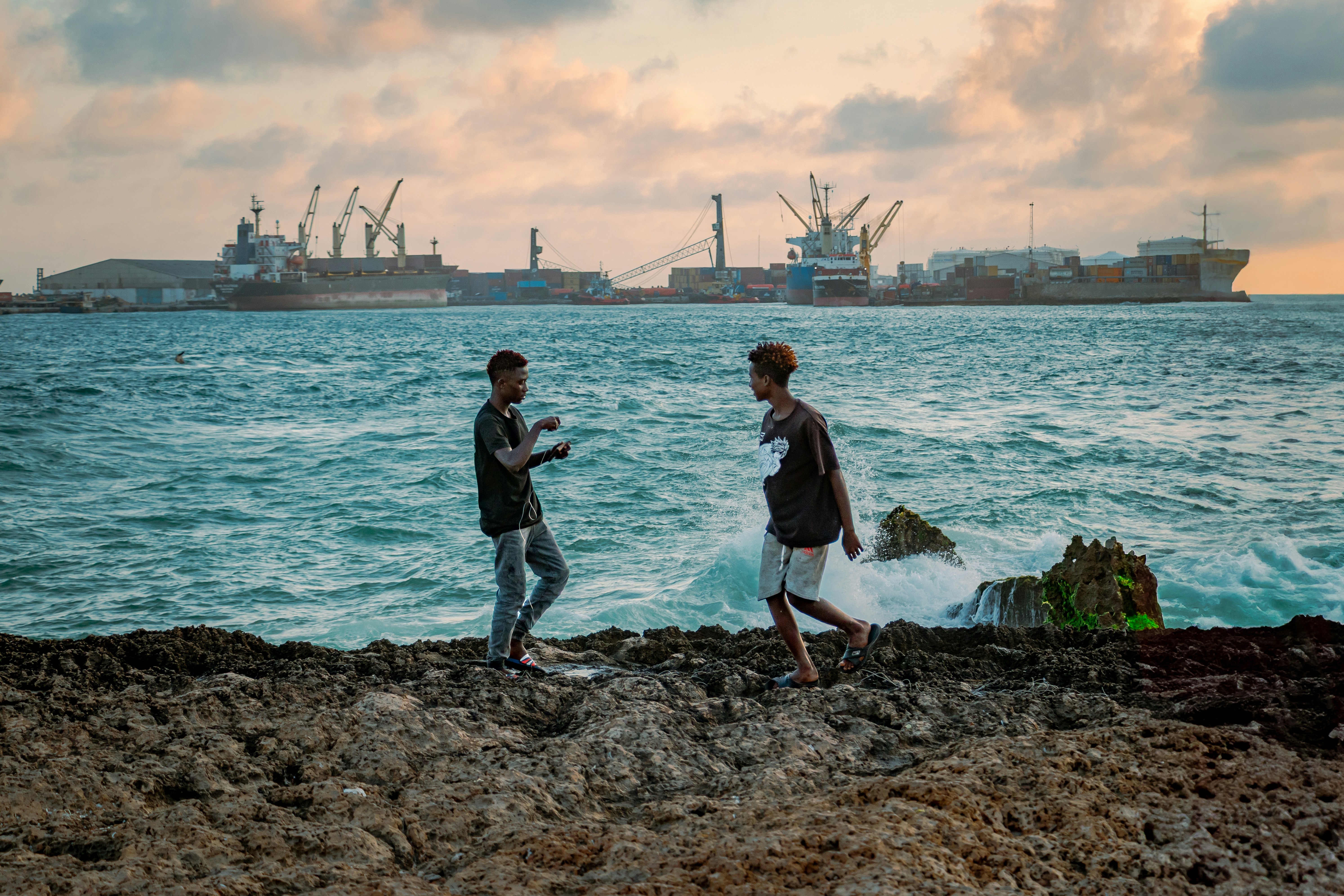 Shoreline Dialogue: Two Friends Against a Harbor Horizon