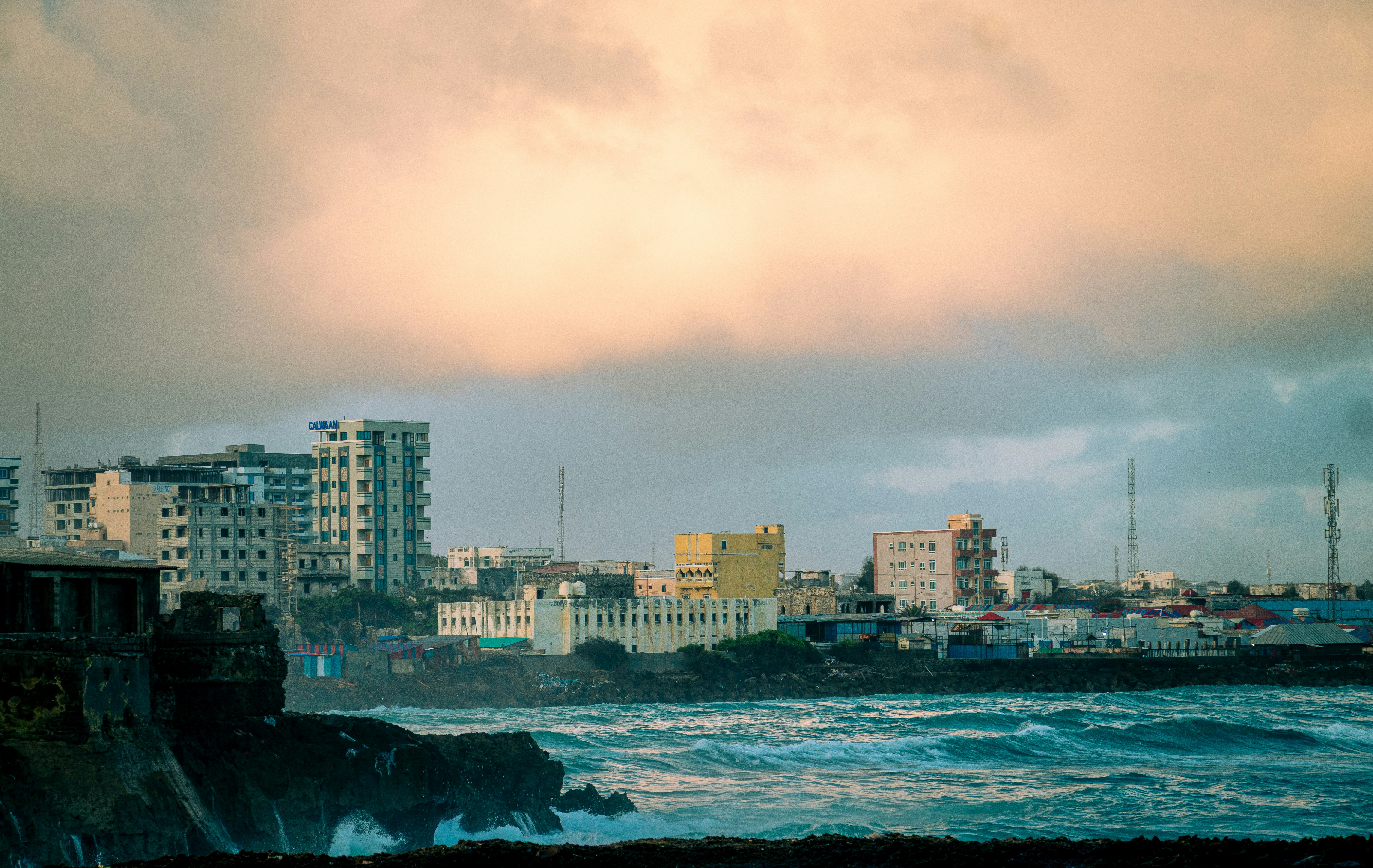 Dusk Harbor: pastel skyline over restless shoreline