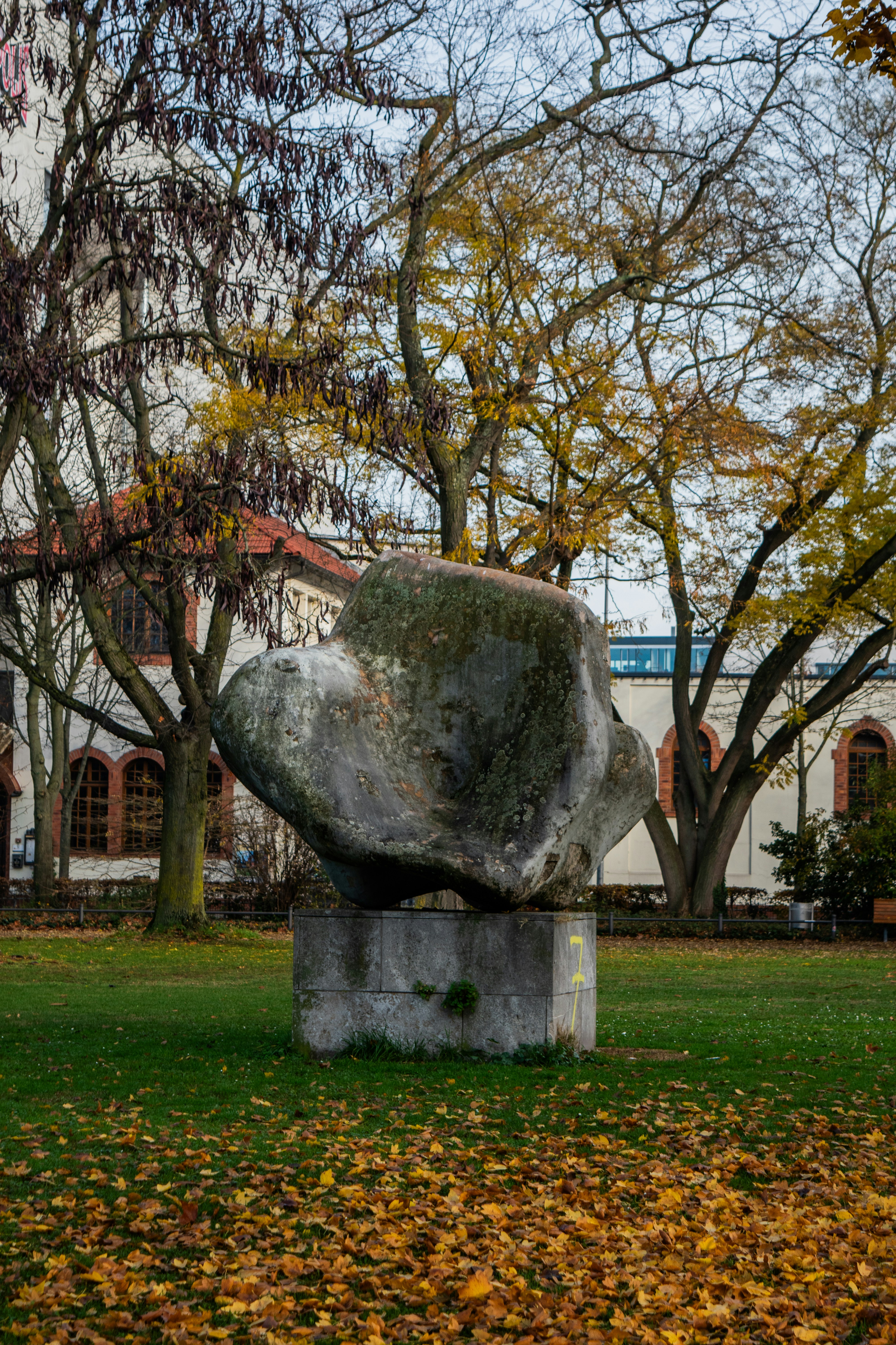Stone Sentinel: Autumn Sculpture in the Park