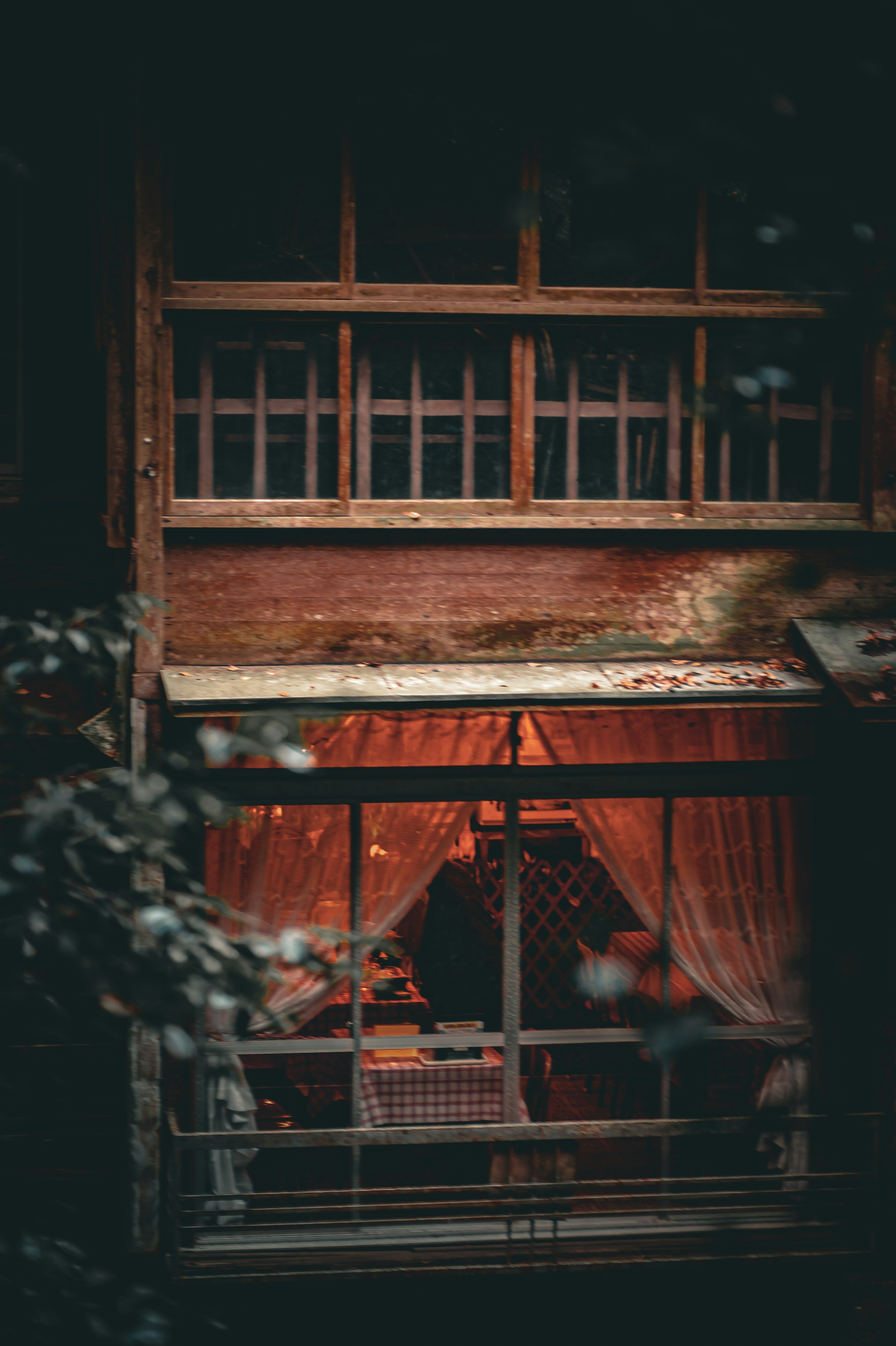 Amber Parlor Behind Weathered Balcony Frames