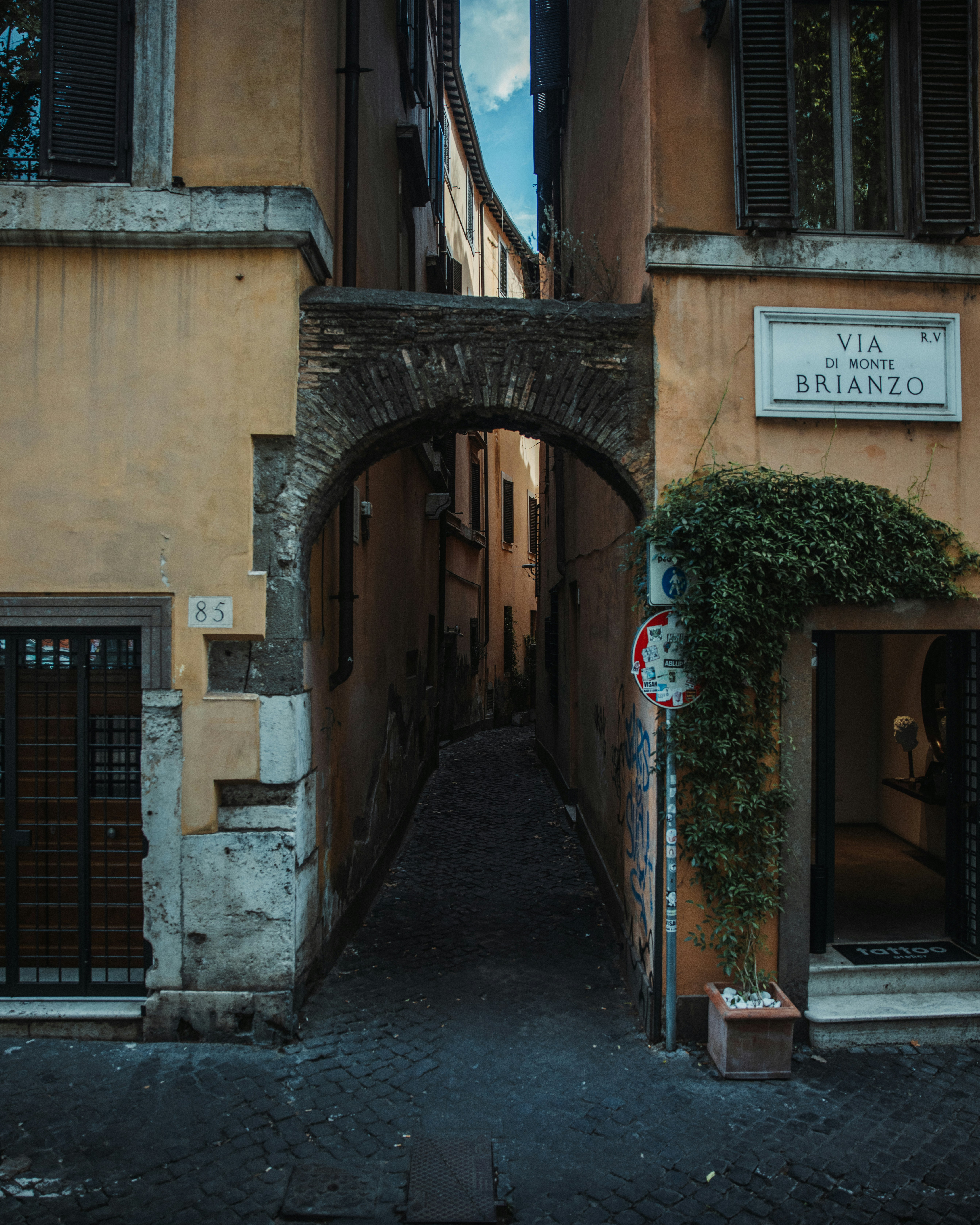 Archway Corridor: A Narrow Italian Alley Between Sunlit Facades