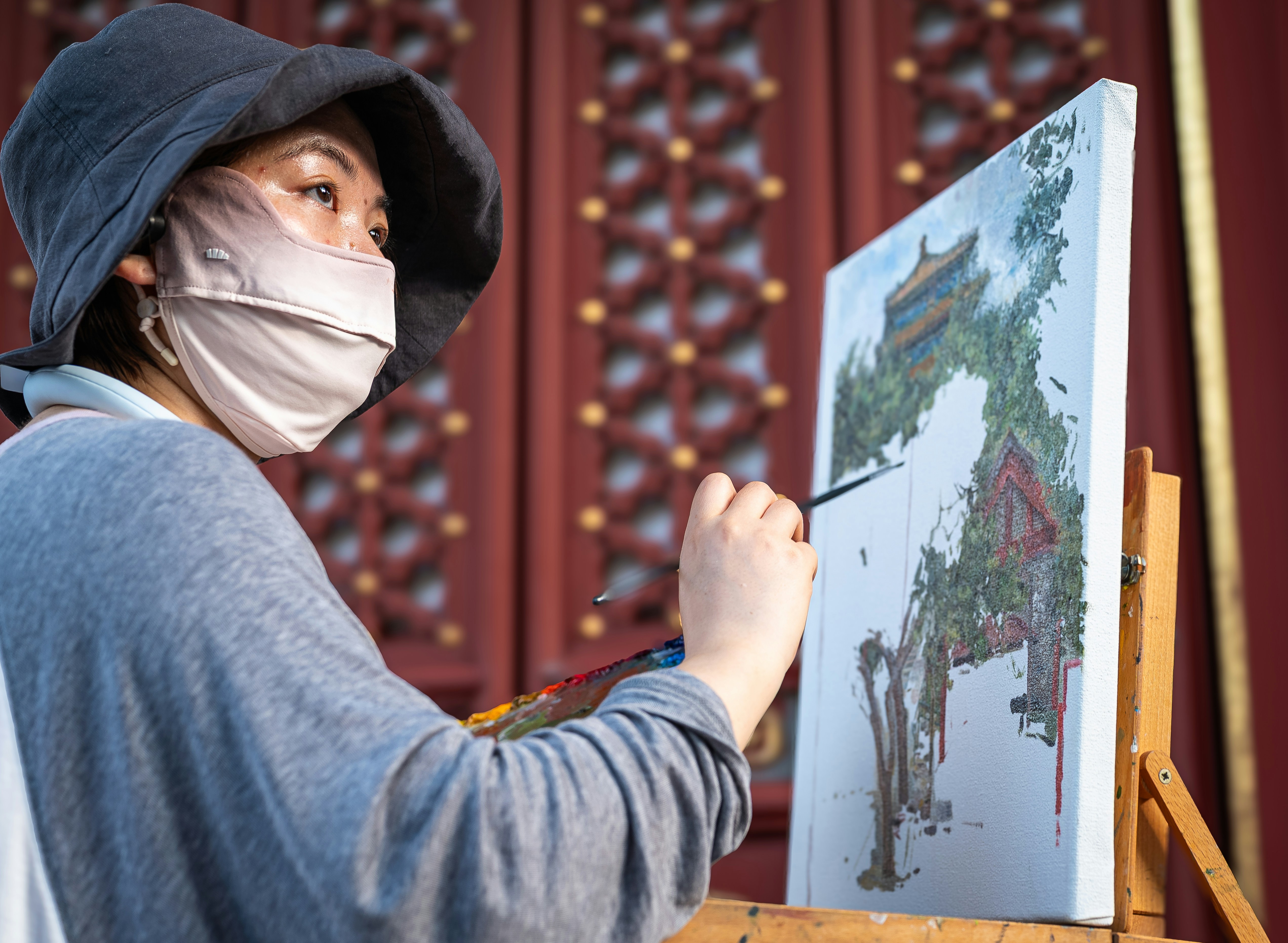 Masked Artist at an Easel, Painting a Temple Gate