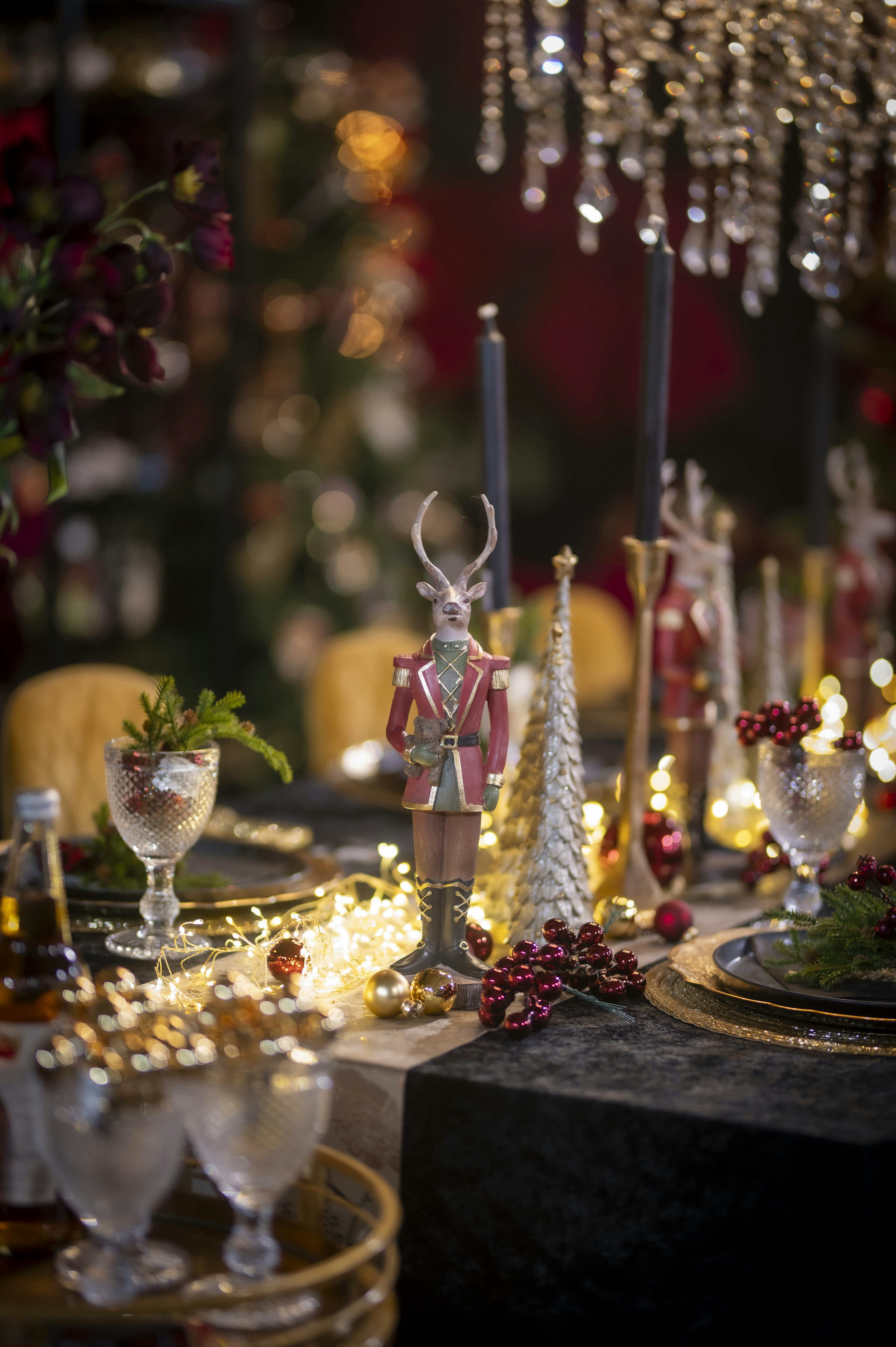 Tiny Reindeer Sentinel Amid a Glittering Holiday Table