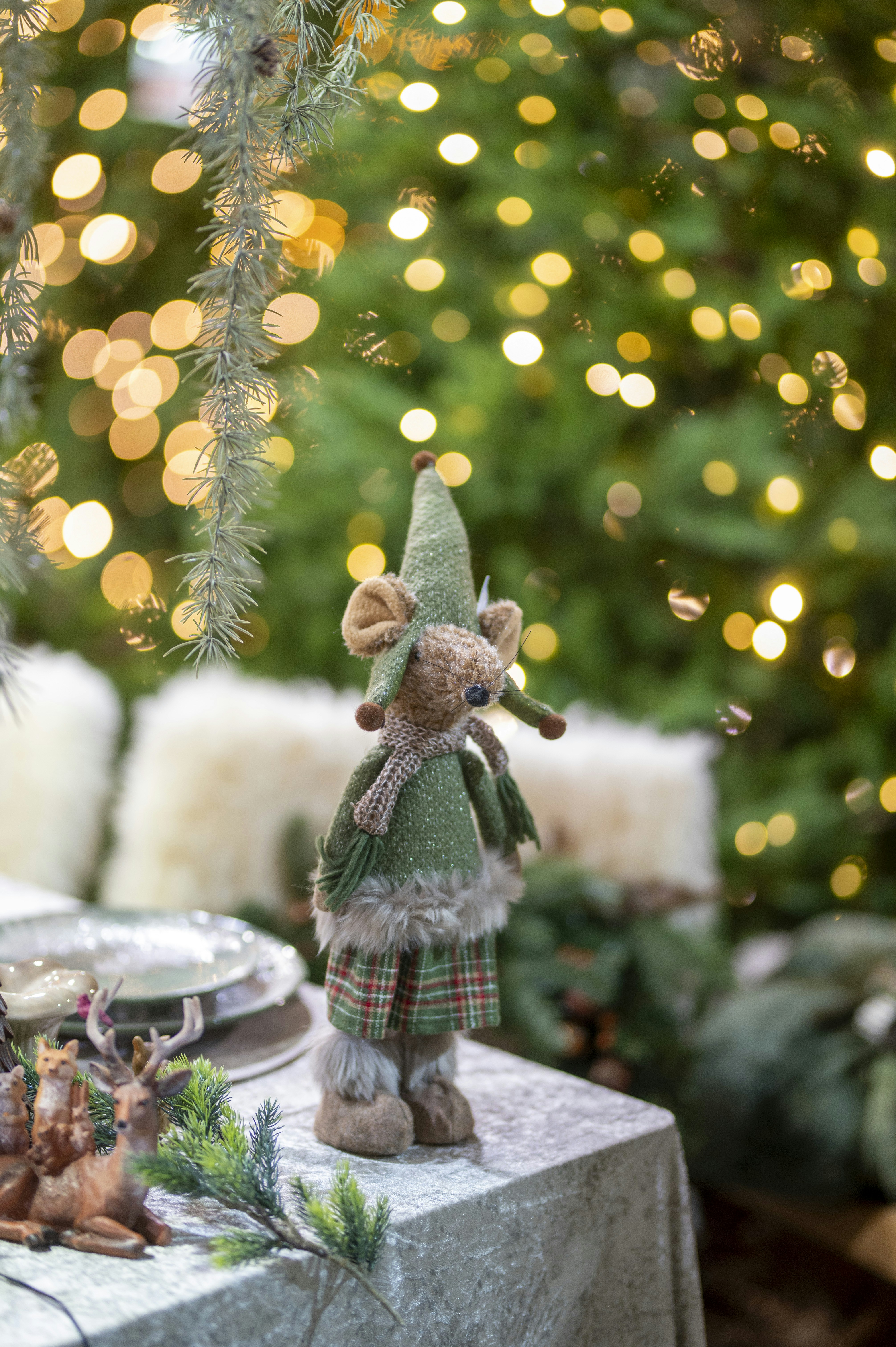 Quiet Festive Sentinel: A Plush Mouse Amid Golden Christmas Bokeh