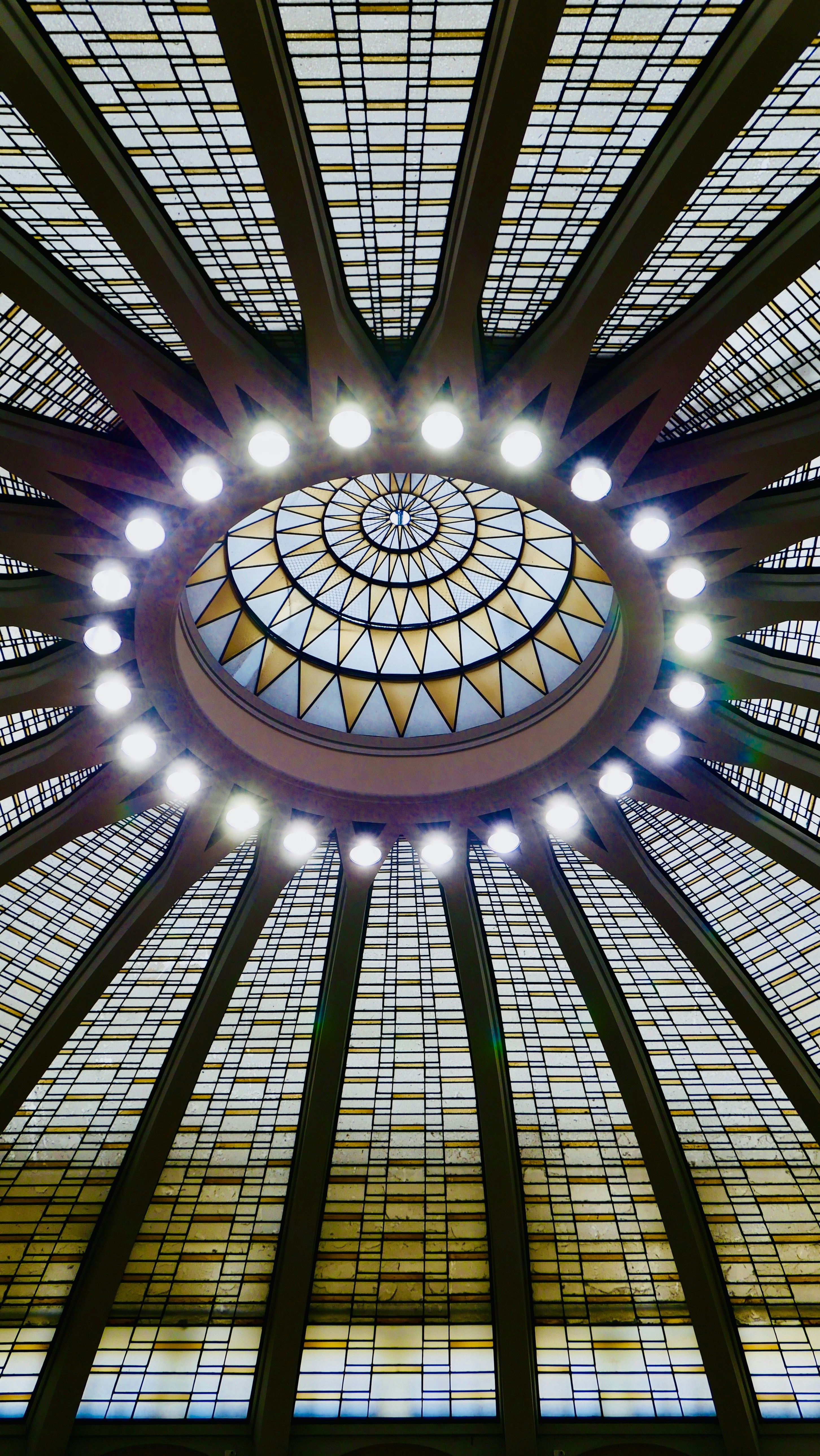 Radial Dome of Light: Concentric Glass Ceiling Framed by Glowing Orbs