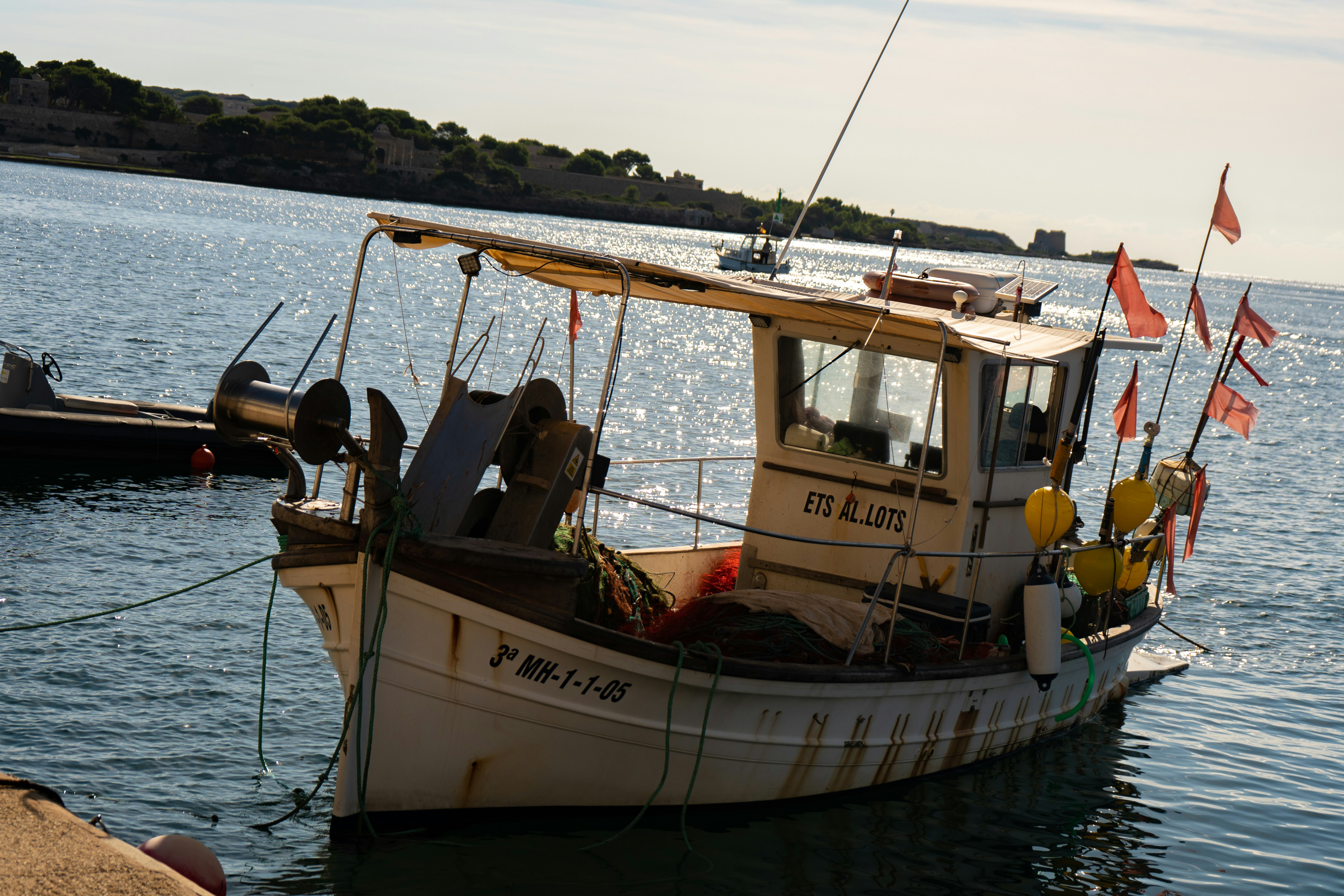 A small fishing boat docked in the harbor. photo – Free Travel Image on ...