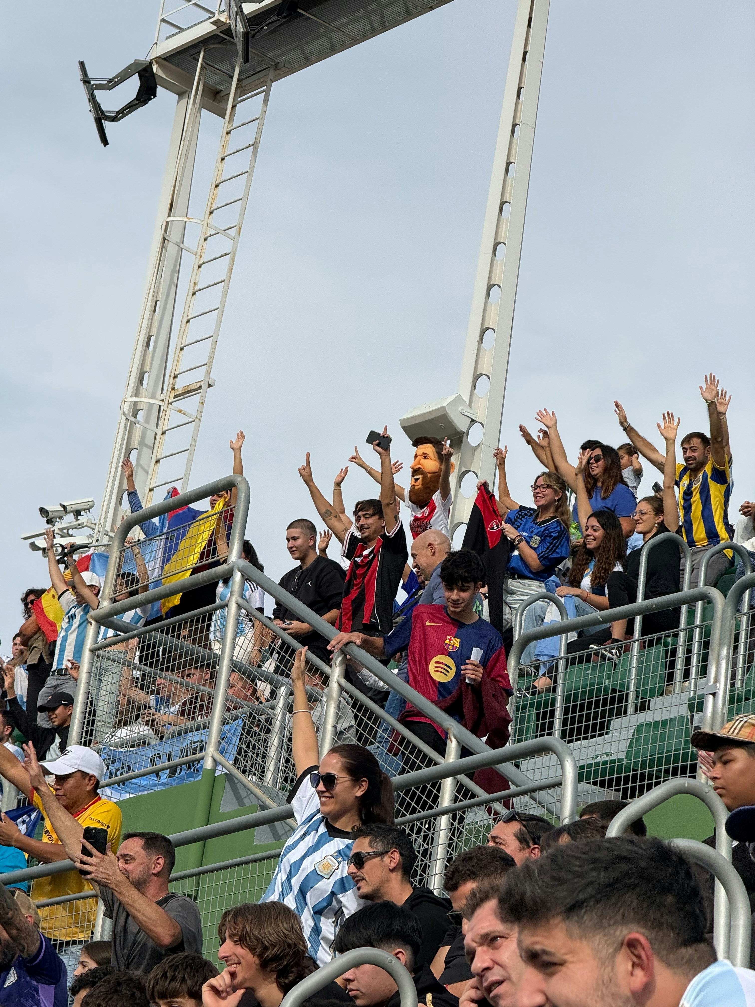 Hands in the Air: A Sunlit Stadium Throng