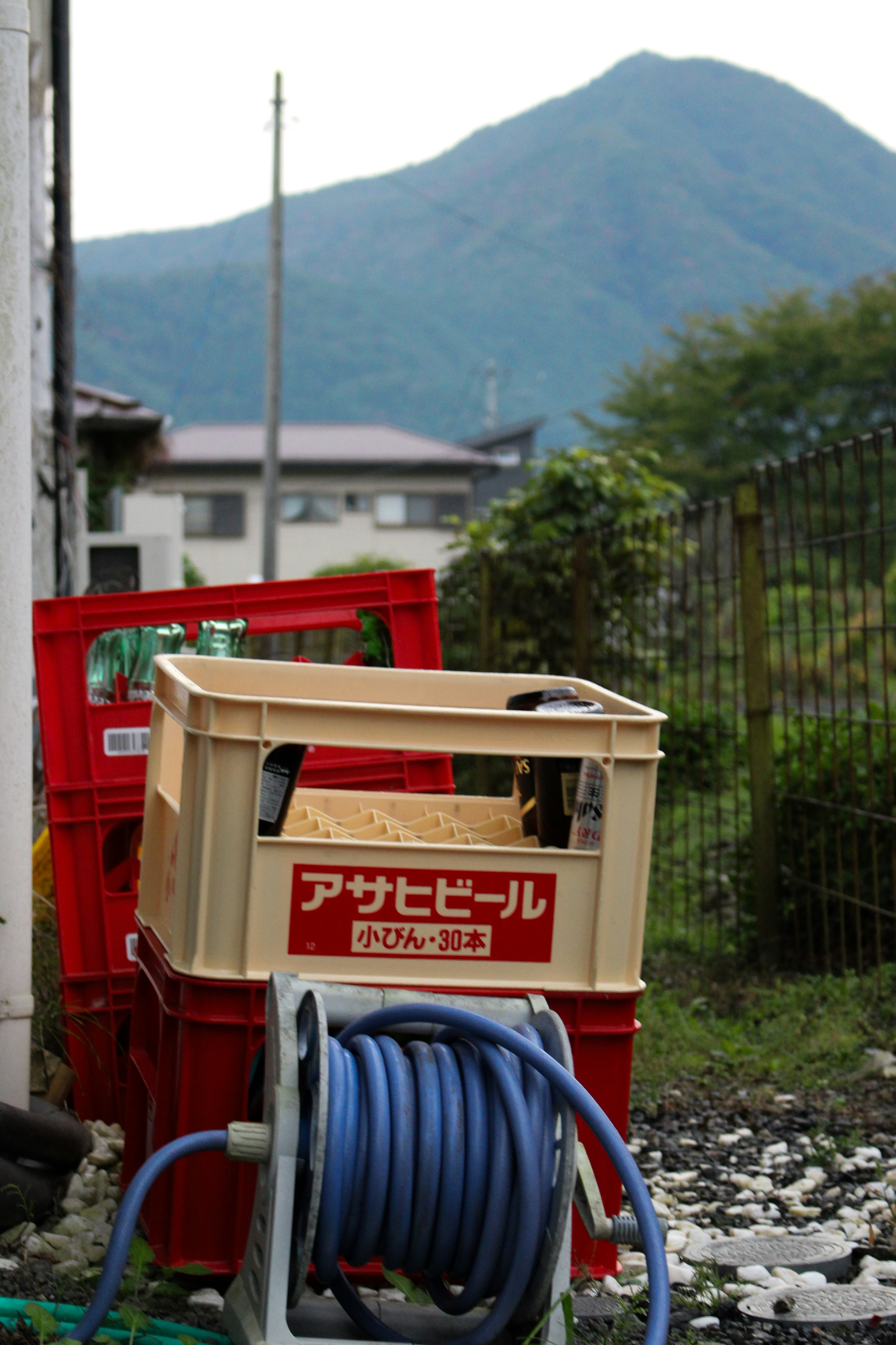 Crates, Coil and Distant Peaks: A Yard Still Life