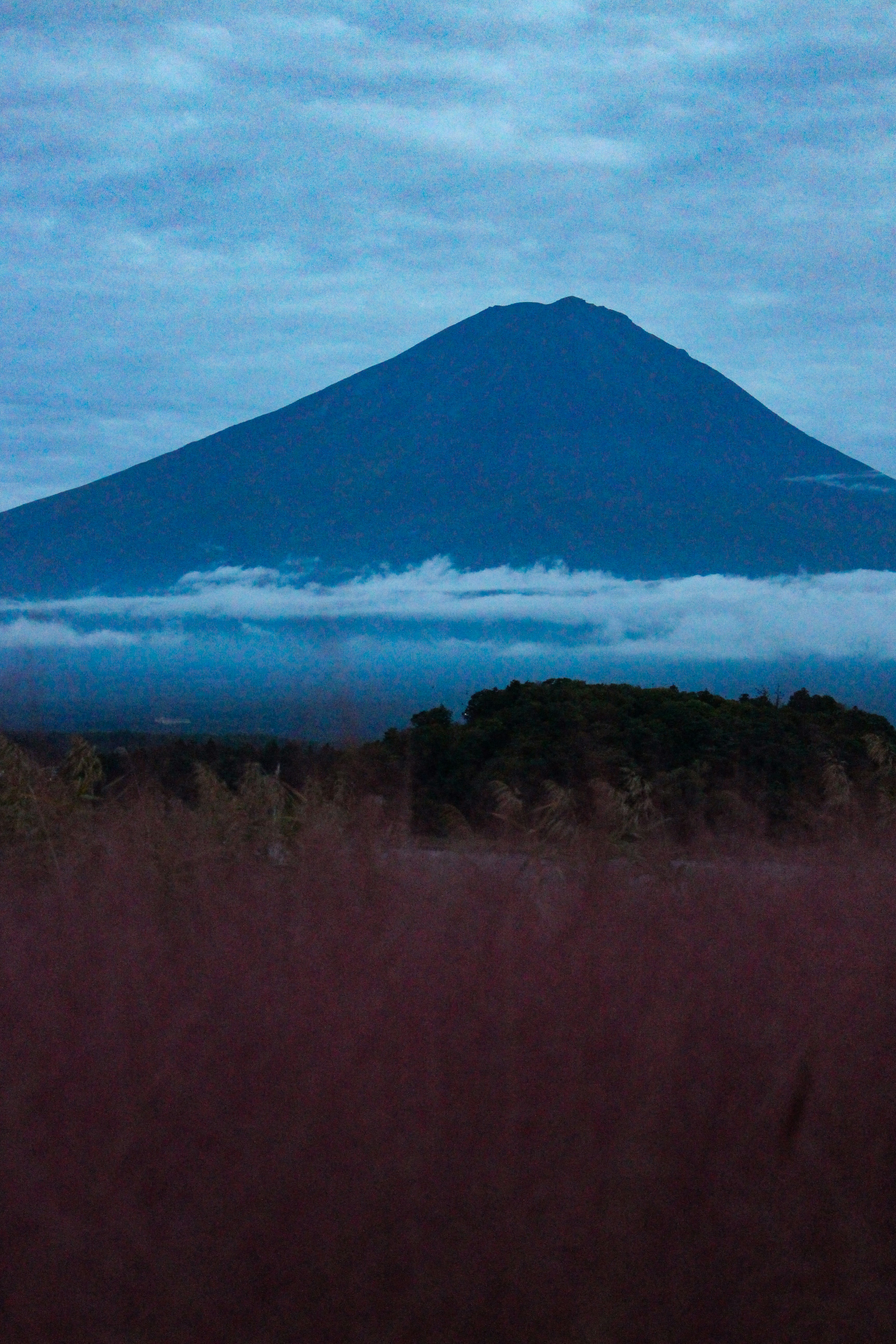 Blue Hour Summit: Cloud-Wreathed Peak and Magenta Field