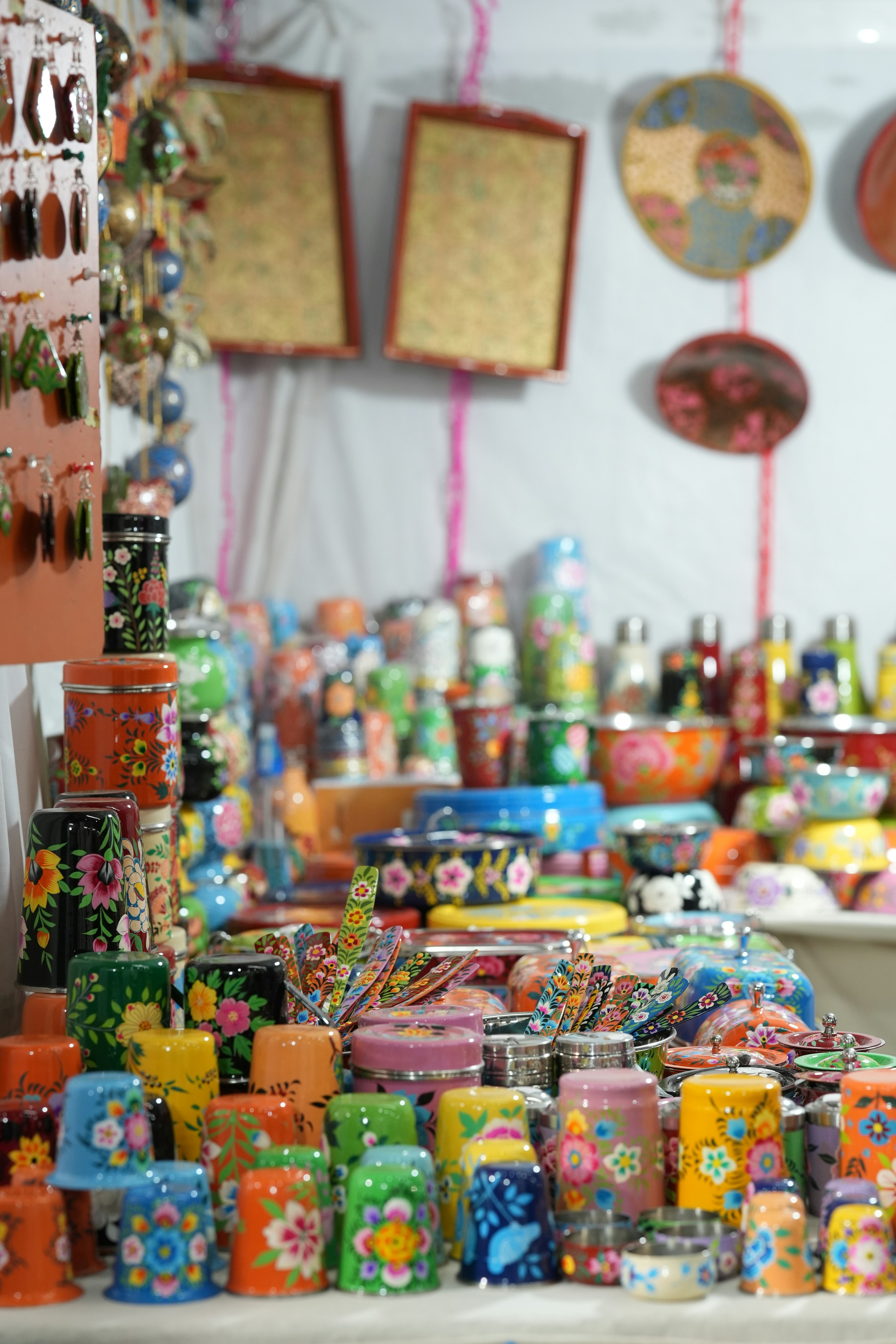 Palette of Ceramics: Hand-Painted Mugs at a Bustling Market Stall