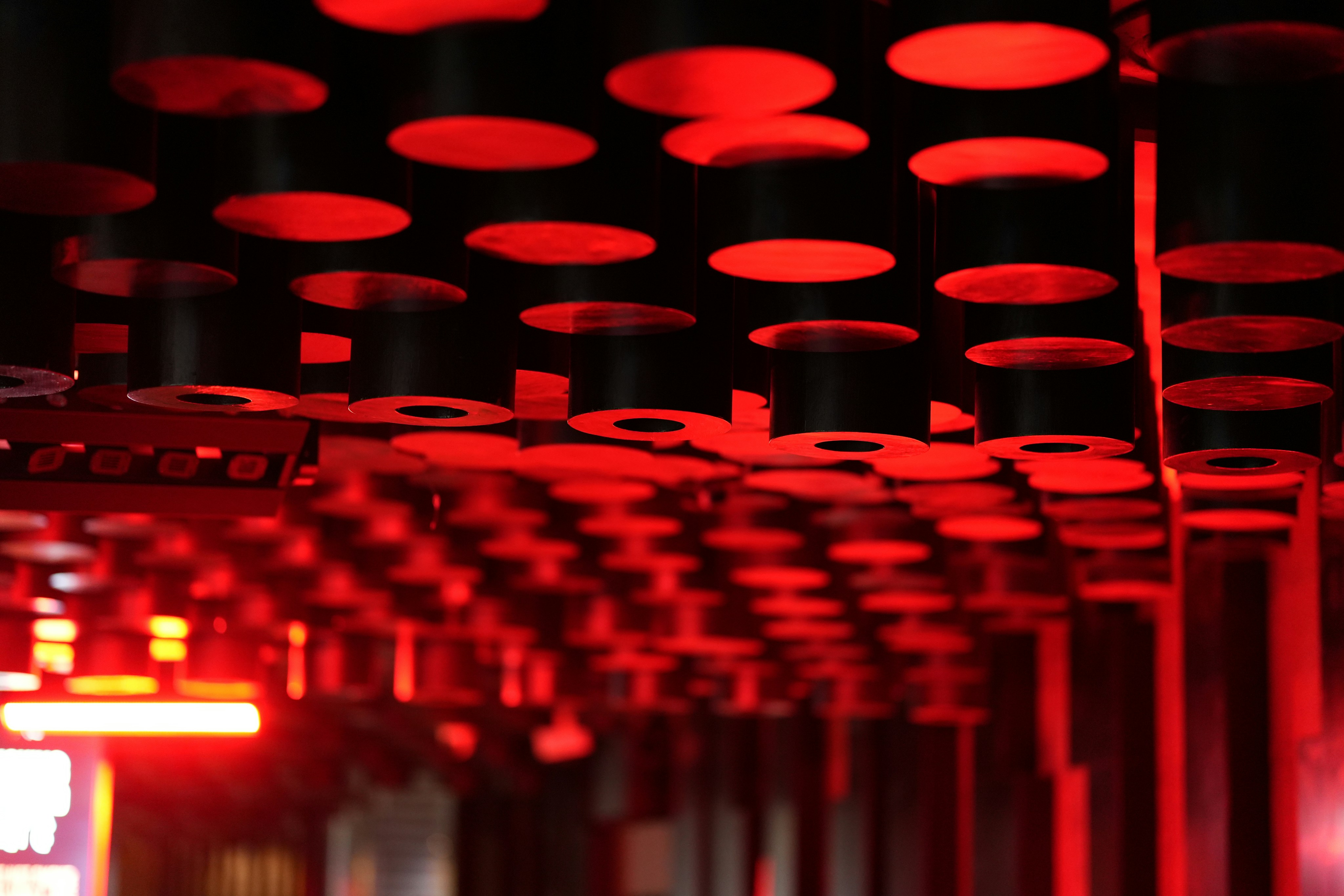 Neon Red Corridor: Circles Reflect in a Night-Driven Tunnel