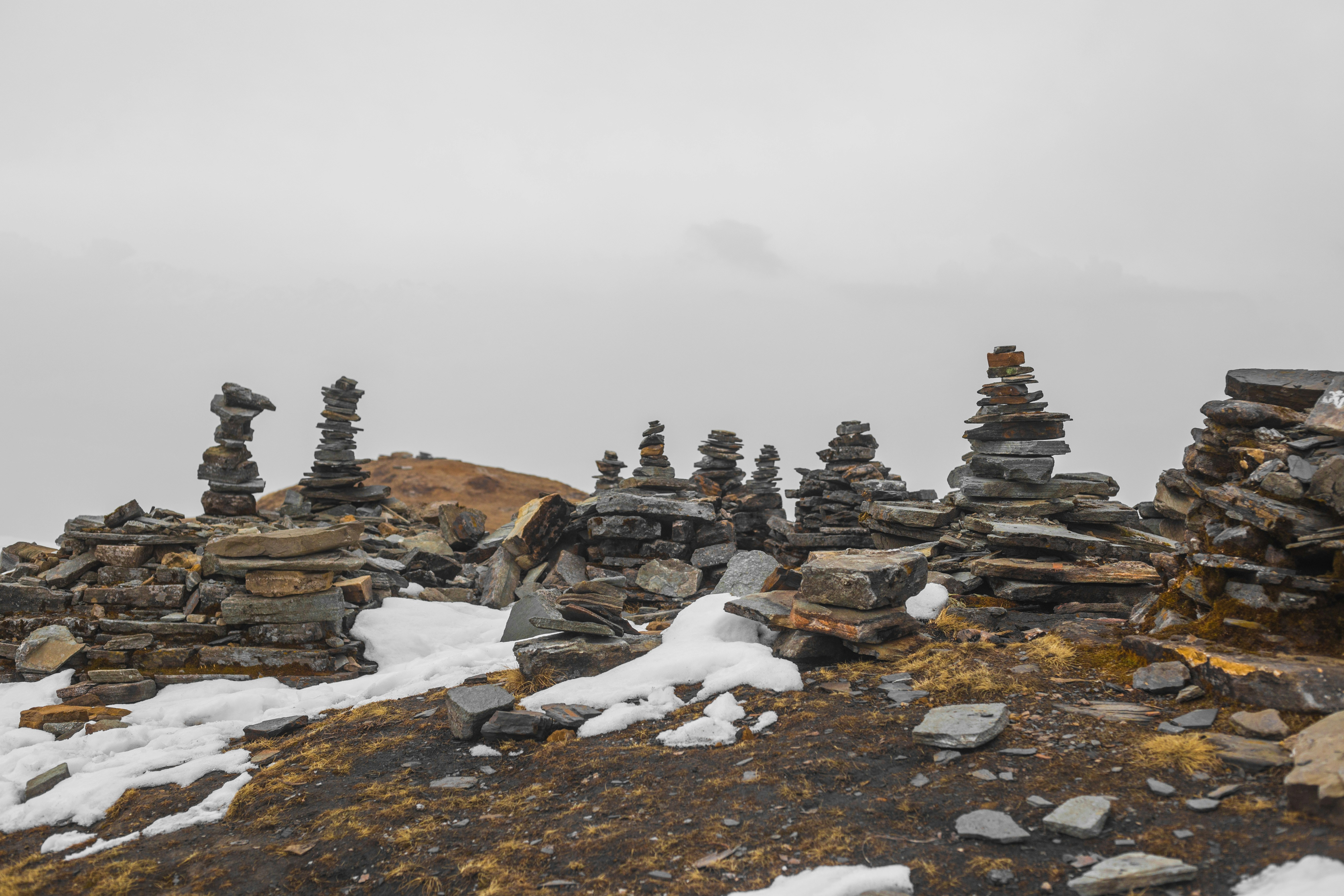 Cairn Towers on a Snow-Dusted Plateau Beneath an Overcast Sky