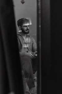 Glass Reflections: A Contemplative Portrait in Mono