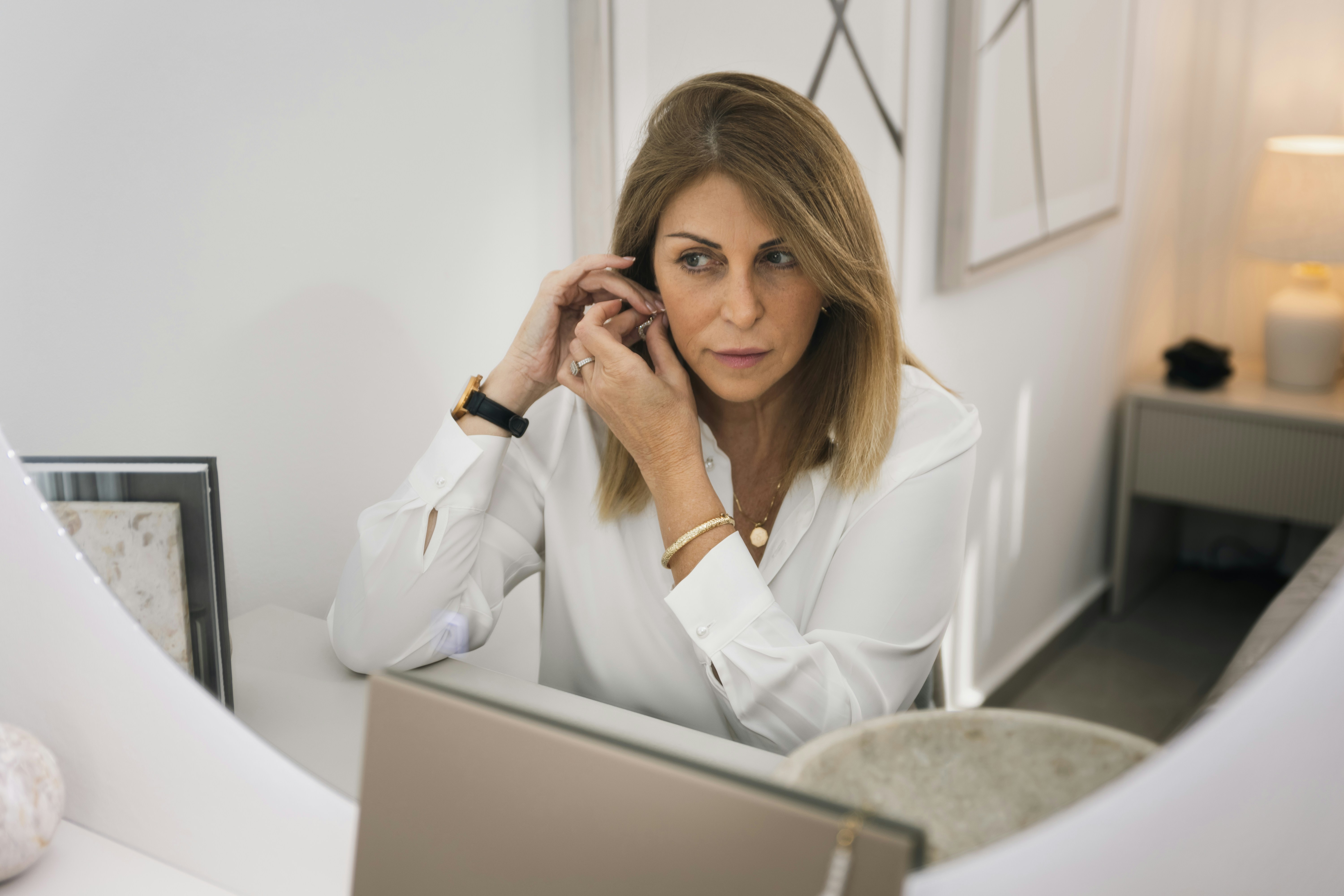 Vanity Moment: A Quiet Earring Preparation in Soft Light