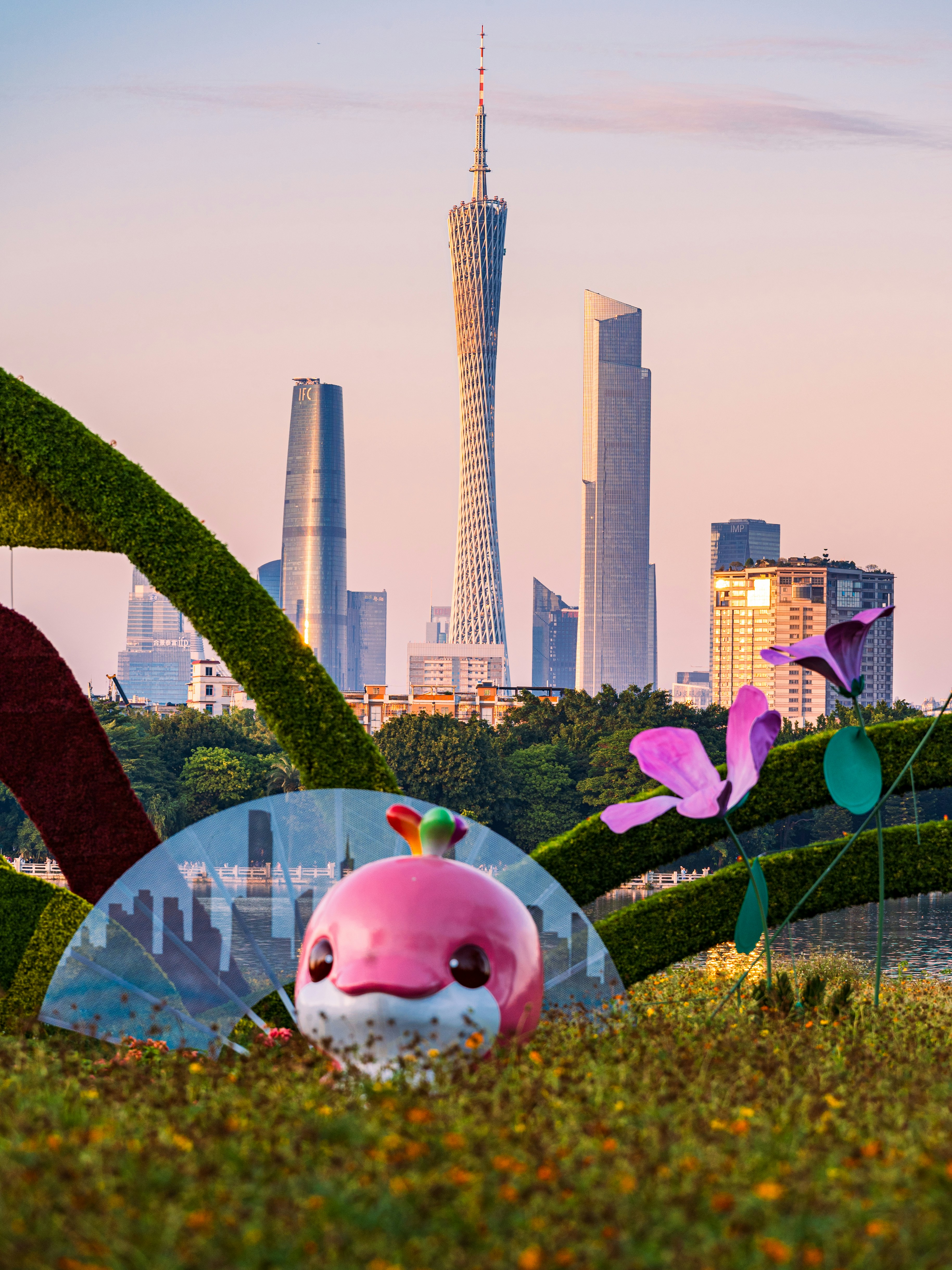 Pastel Park Sentinel: A Pink Cartoon Foreground Framing Guangzhou's Skyline