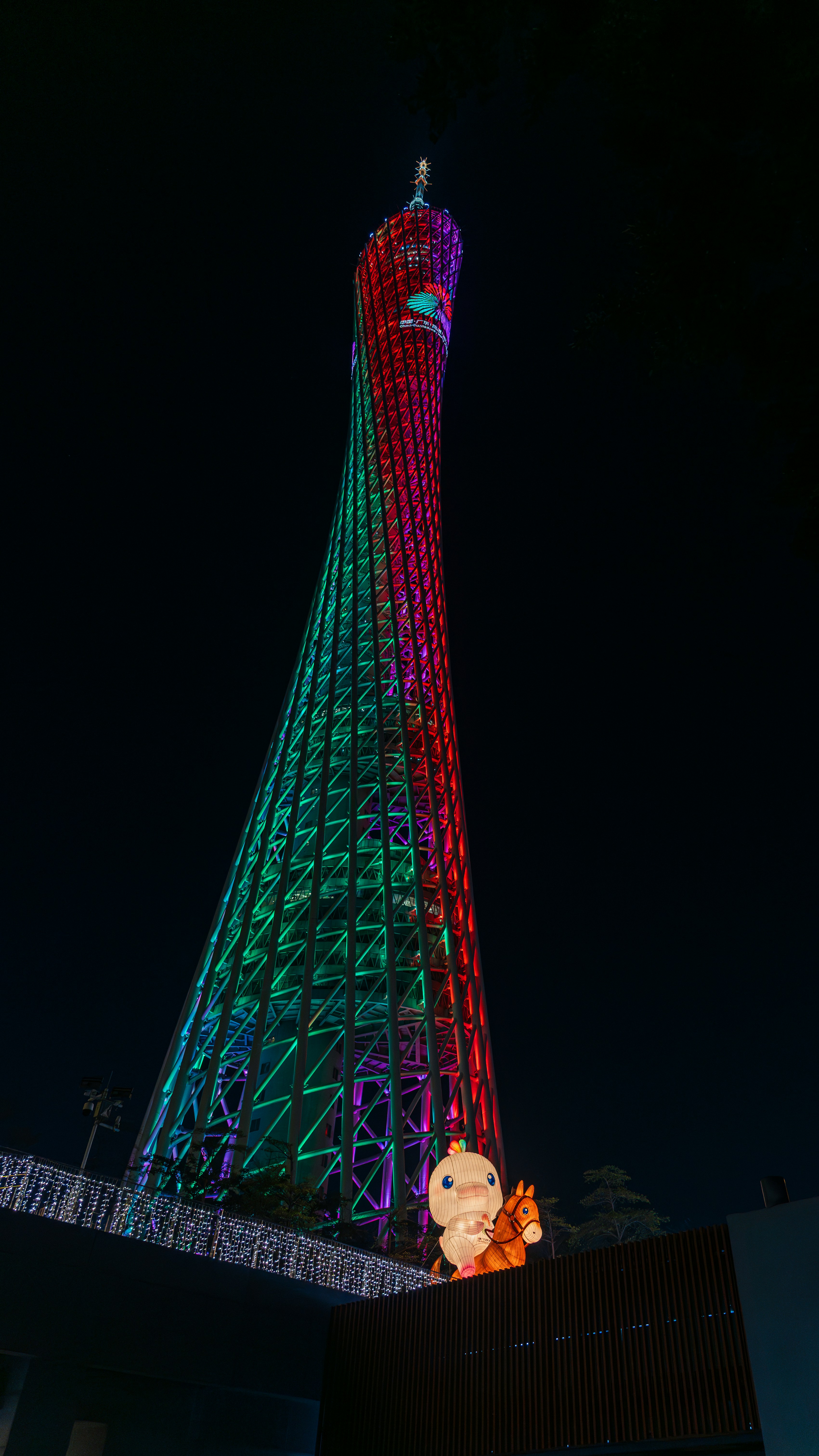 Rainbow Spiral Ascends: The Canton Tower in Nighttime Neon