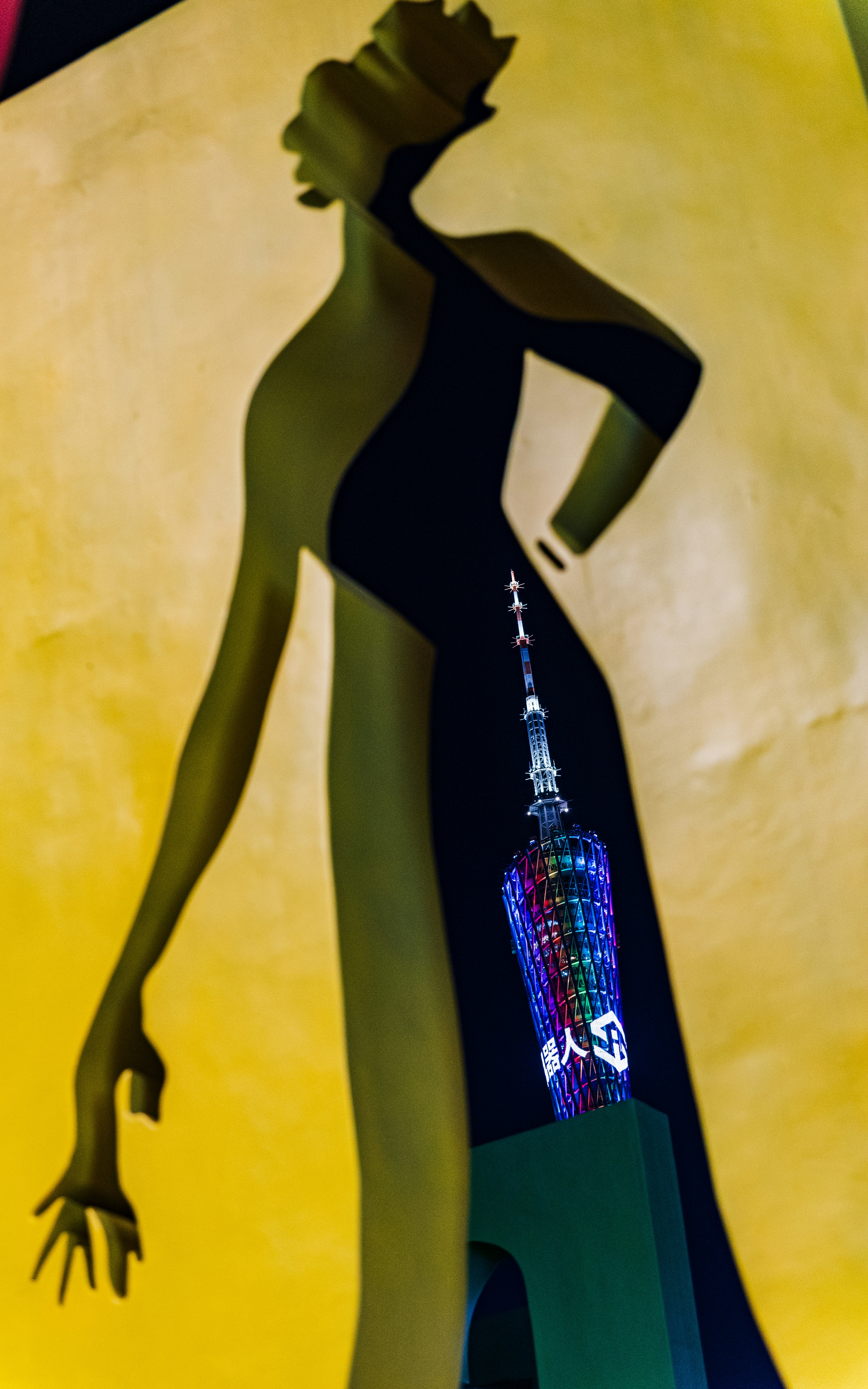 Neon Spire Emerges Behind a Golden Silhouette