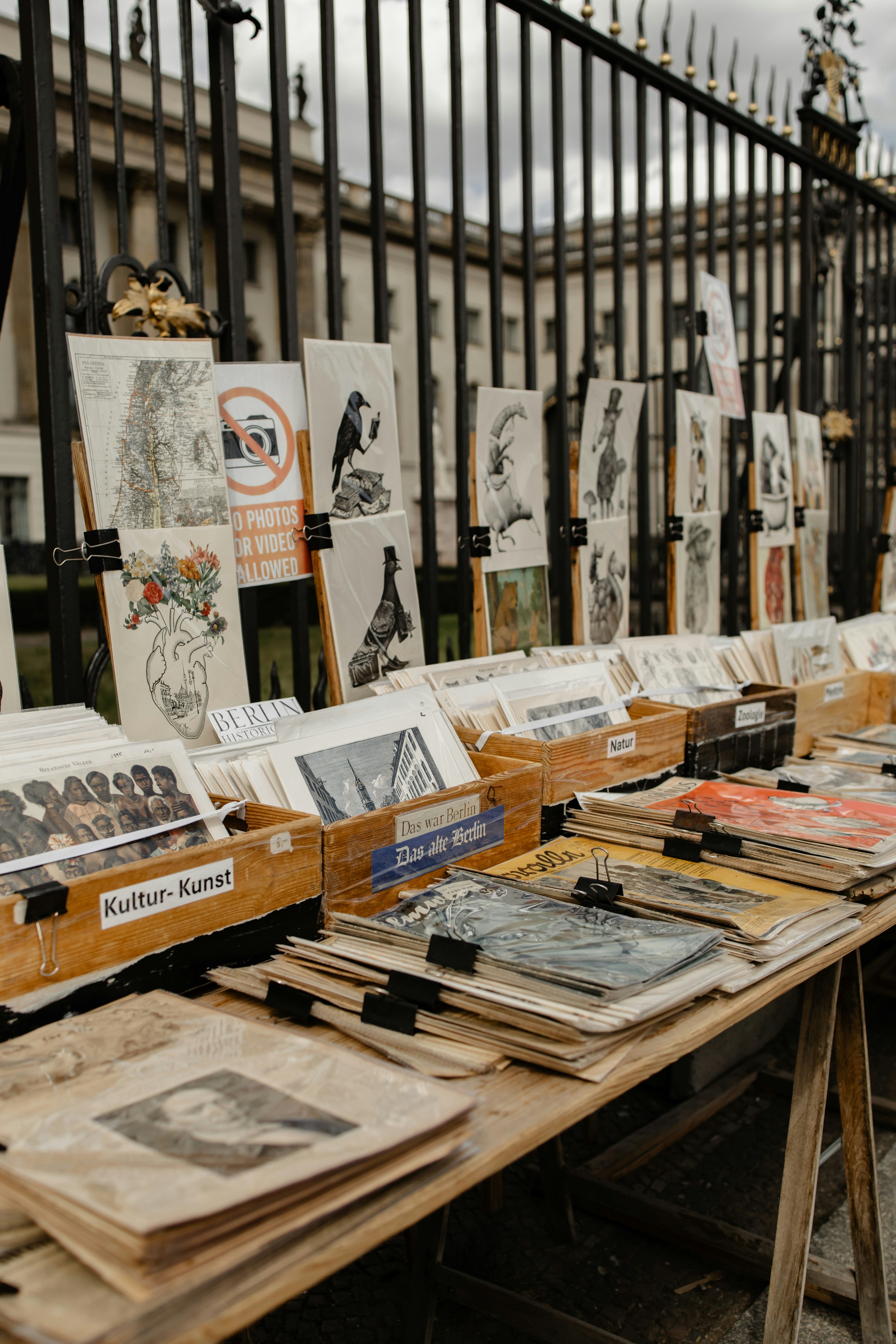 Ephemeral Gallery Along the Rail: Posters and Print Ephemera Spread on a Market Table
