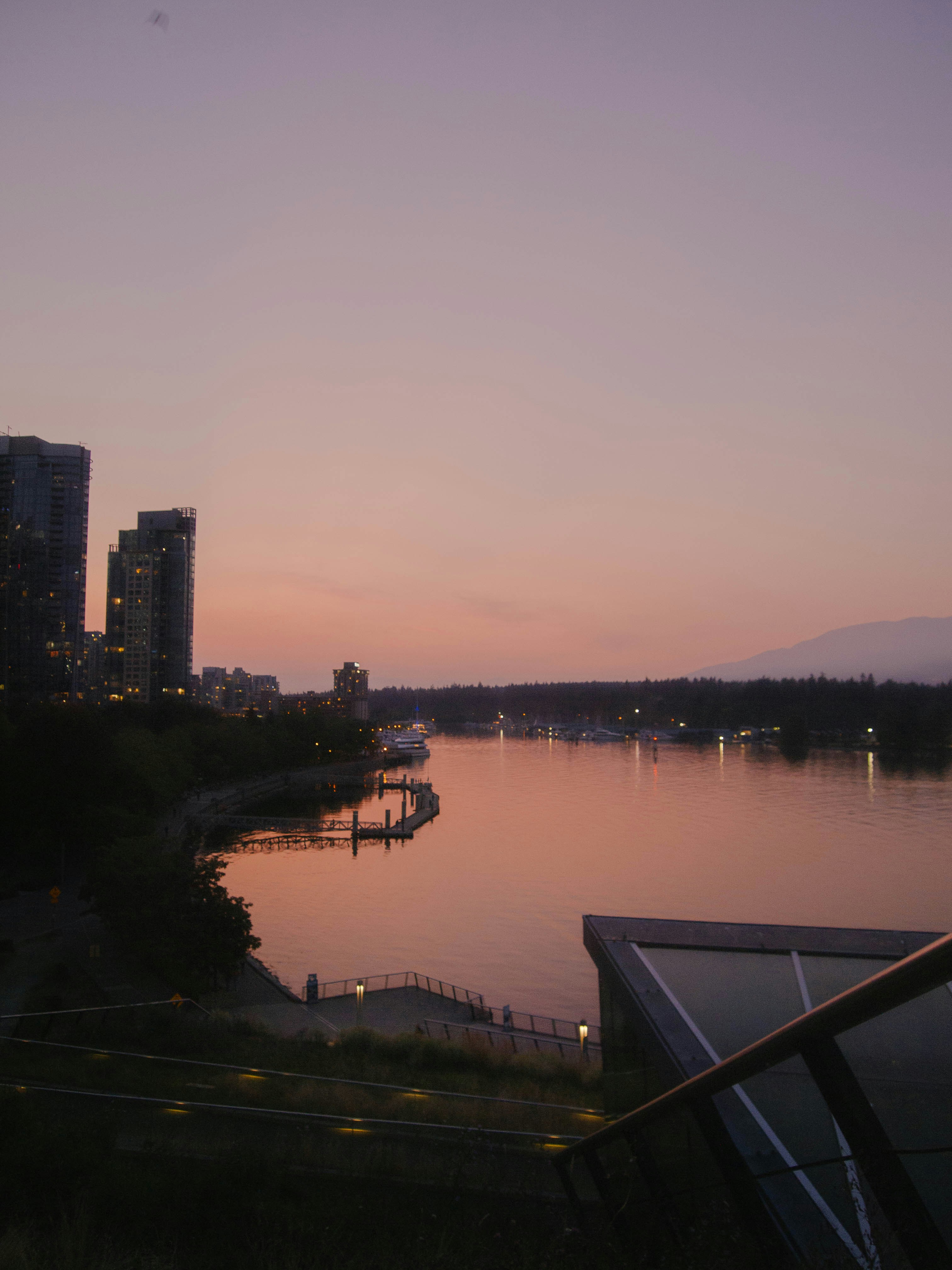 Dusk Over Riverside: City Lights Mirror the Quiet Water