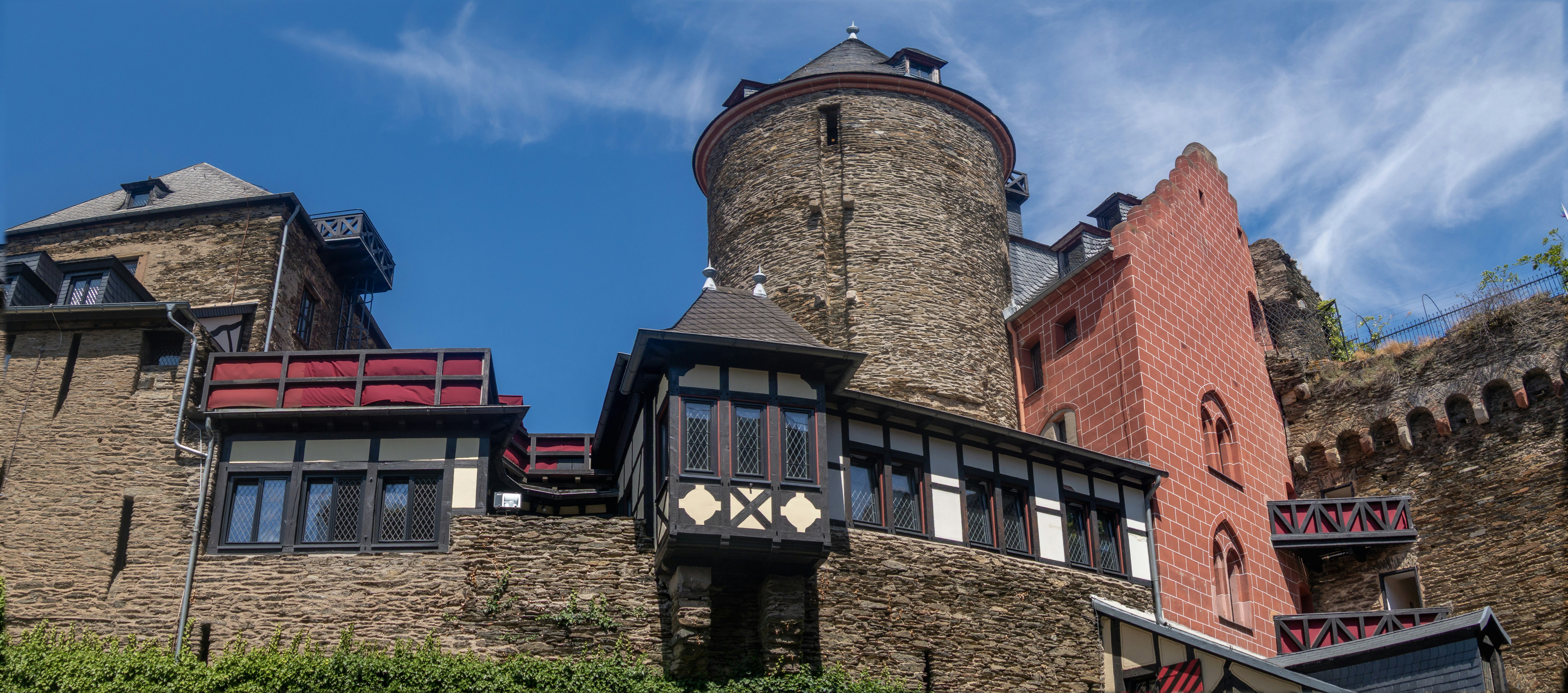 Stone Keep Under a Clear Sky: A Hilltop Fortress with Timbered Wings