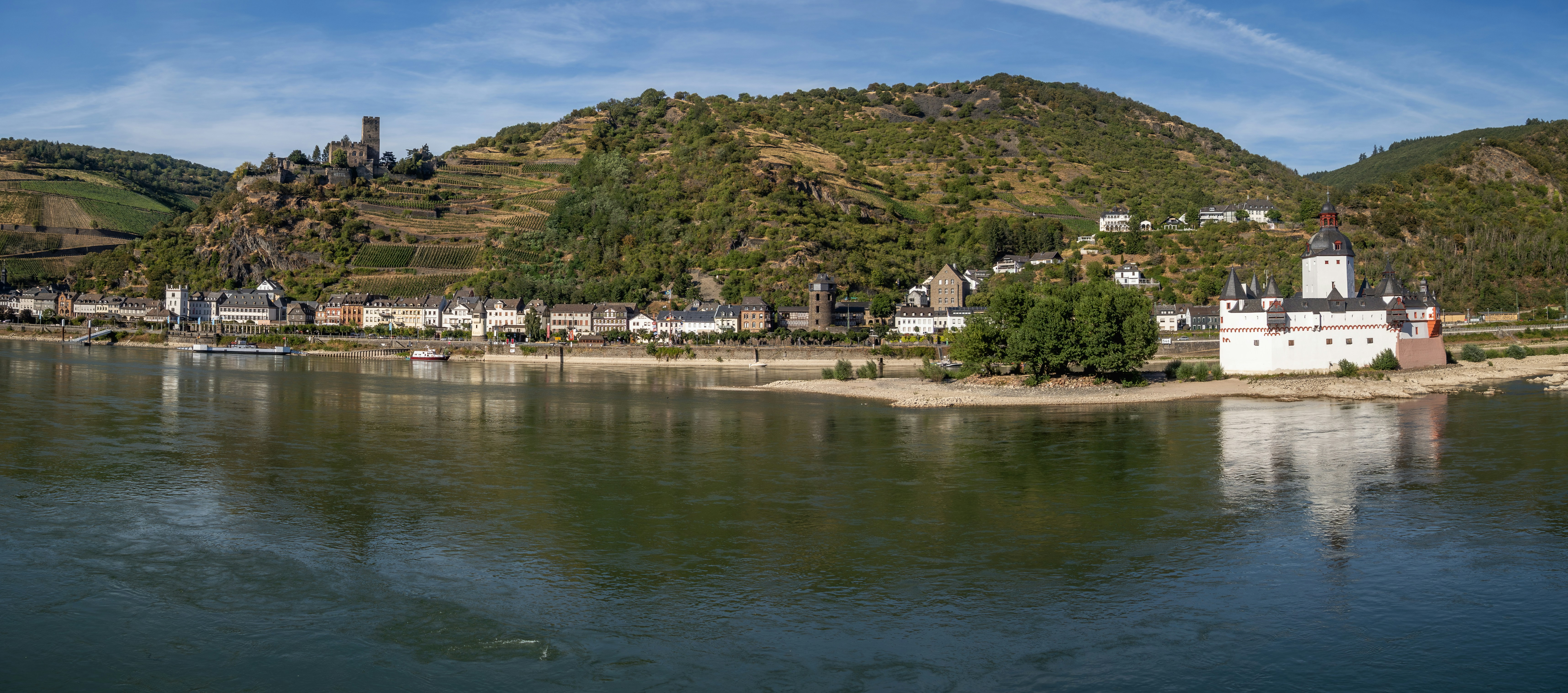 Hilltop Castle Over a Terraced Riverside Village