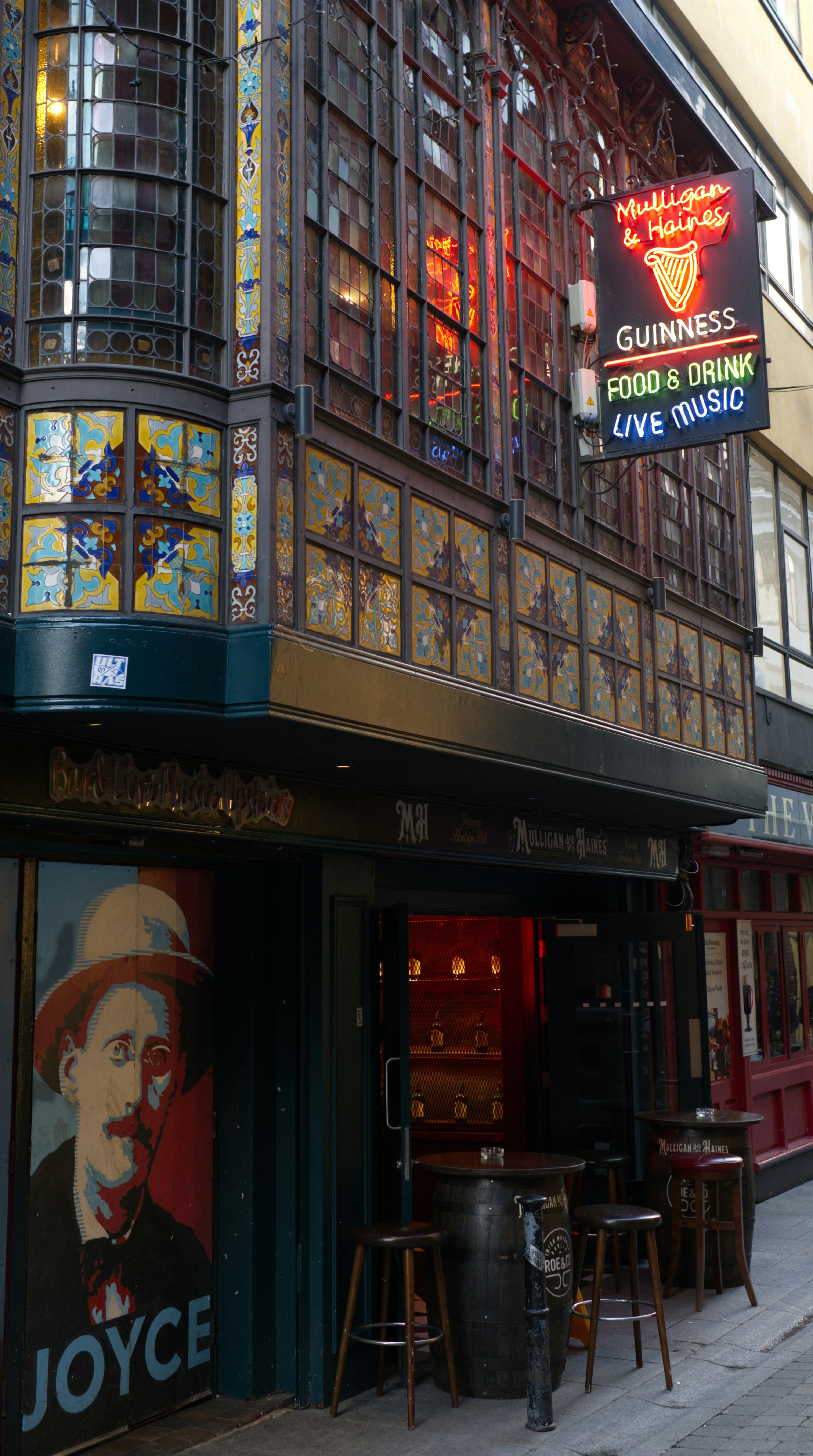 Neon Guinness Sign Over a Mosaic Pubfront