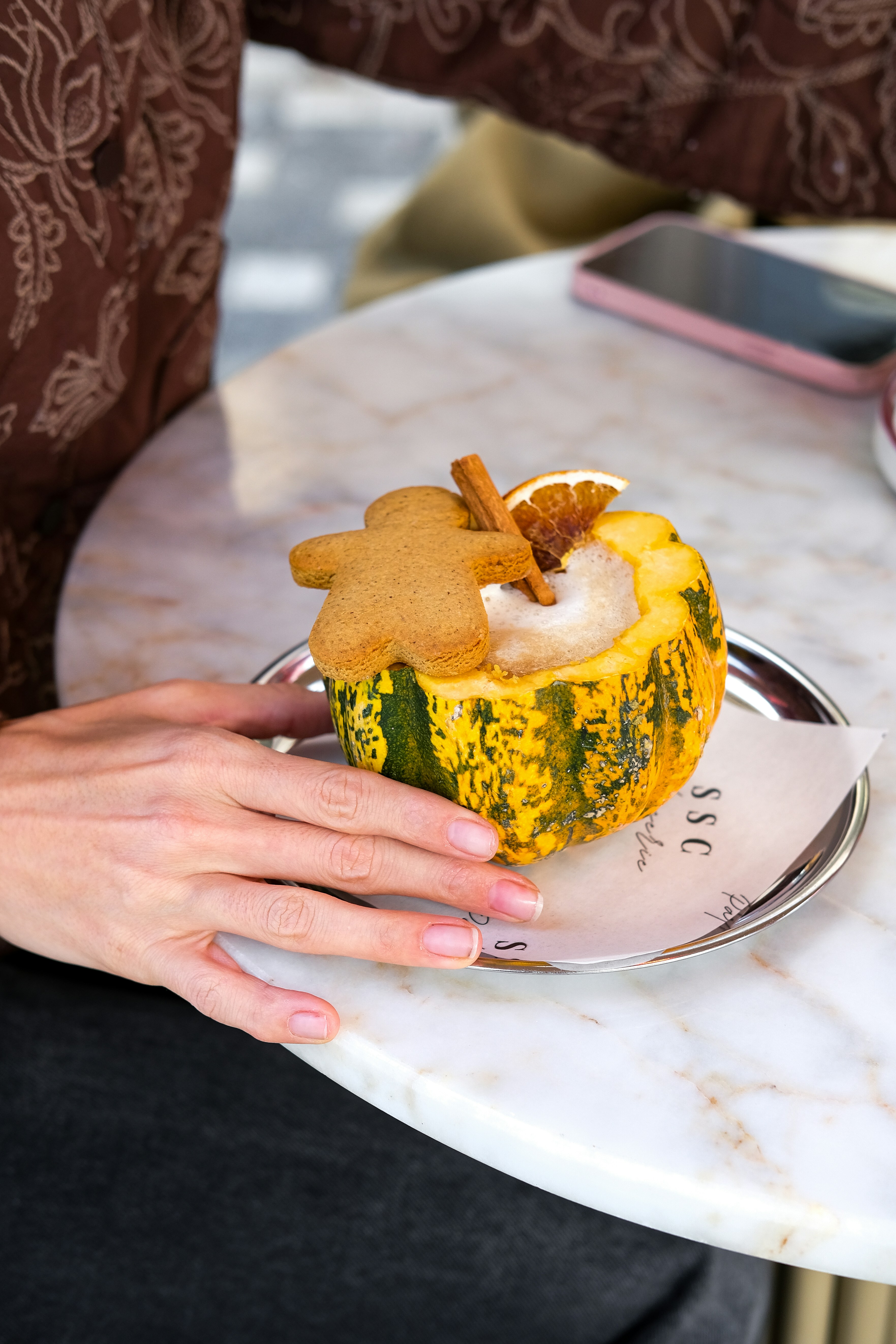 Citrus Vessel: Pumpkin Cup on Marble Table with Cookie Garnish