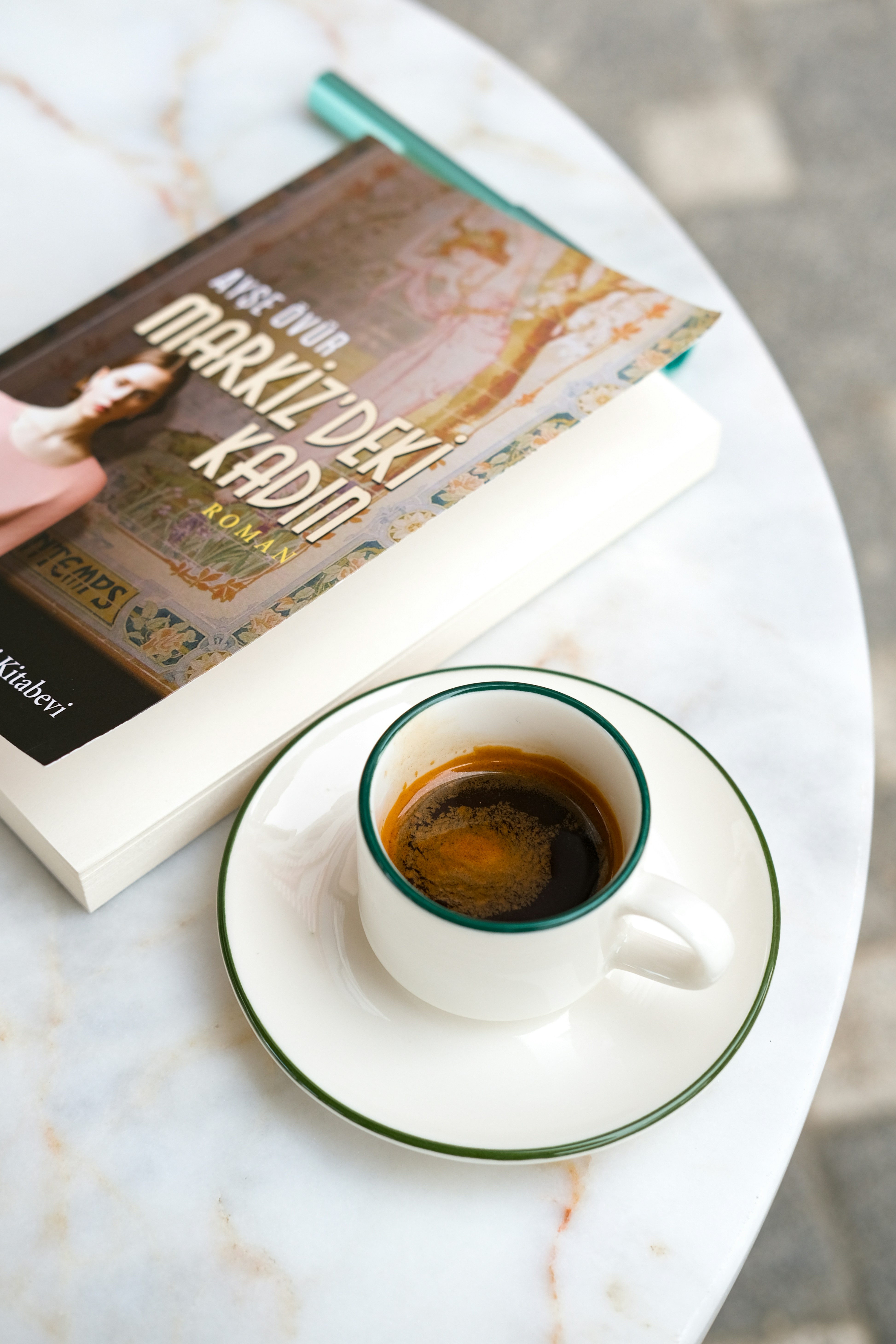 A Quiet Espresso Moment: Coffee, a Novel, and a Sunlit Marble Table
