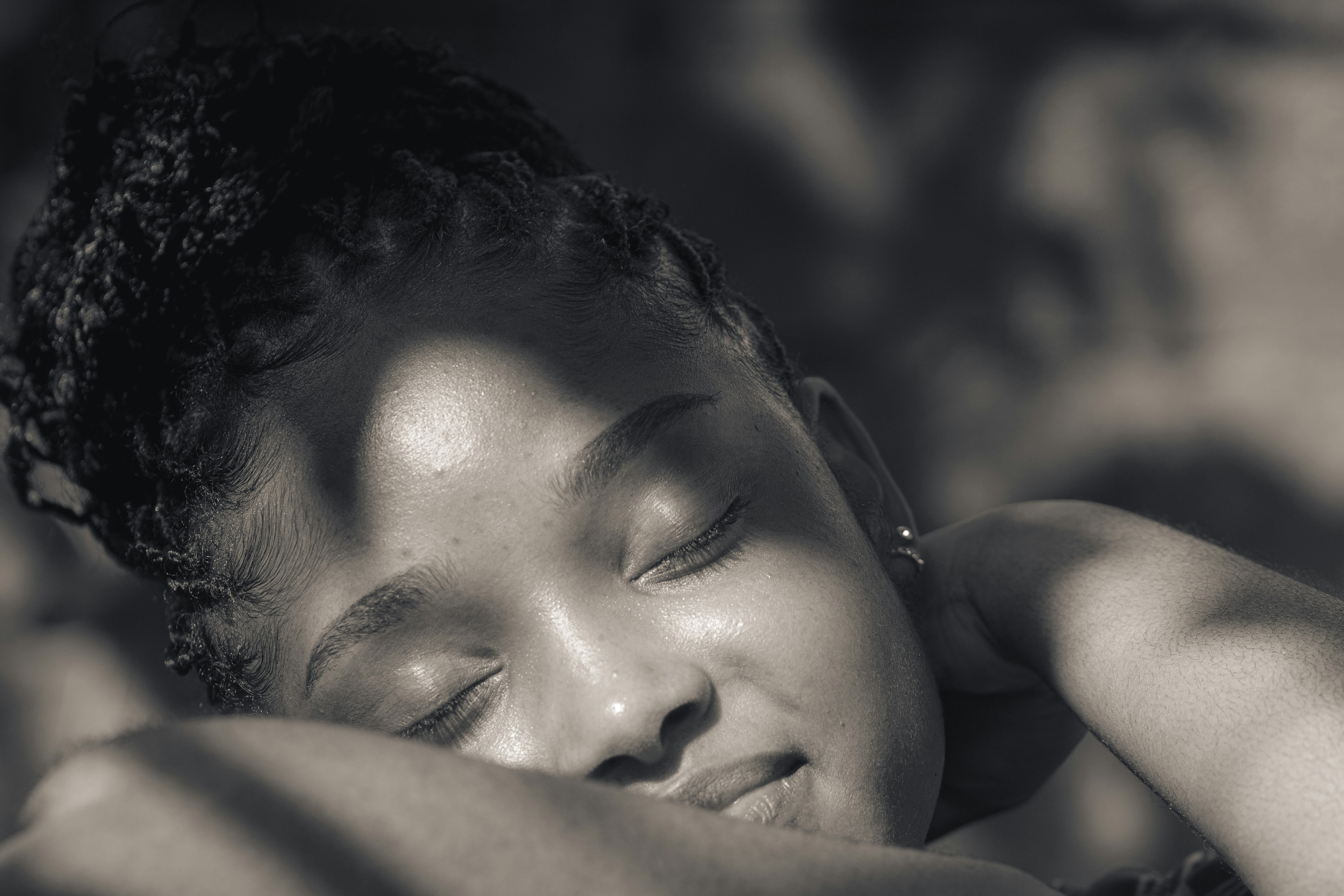 Young woman sleeping peacefully with sunlight on face