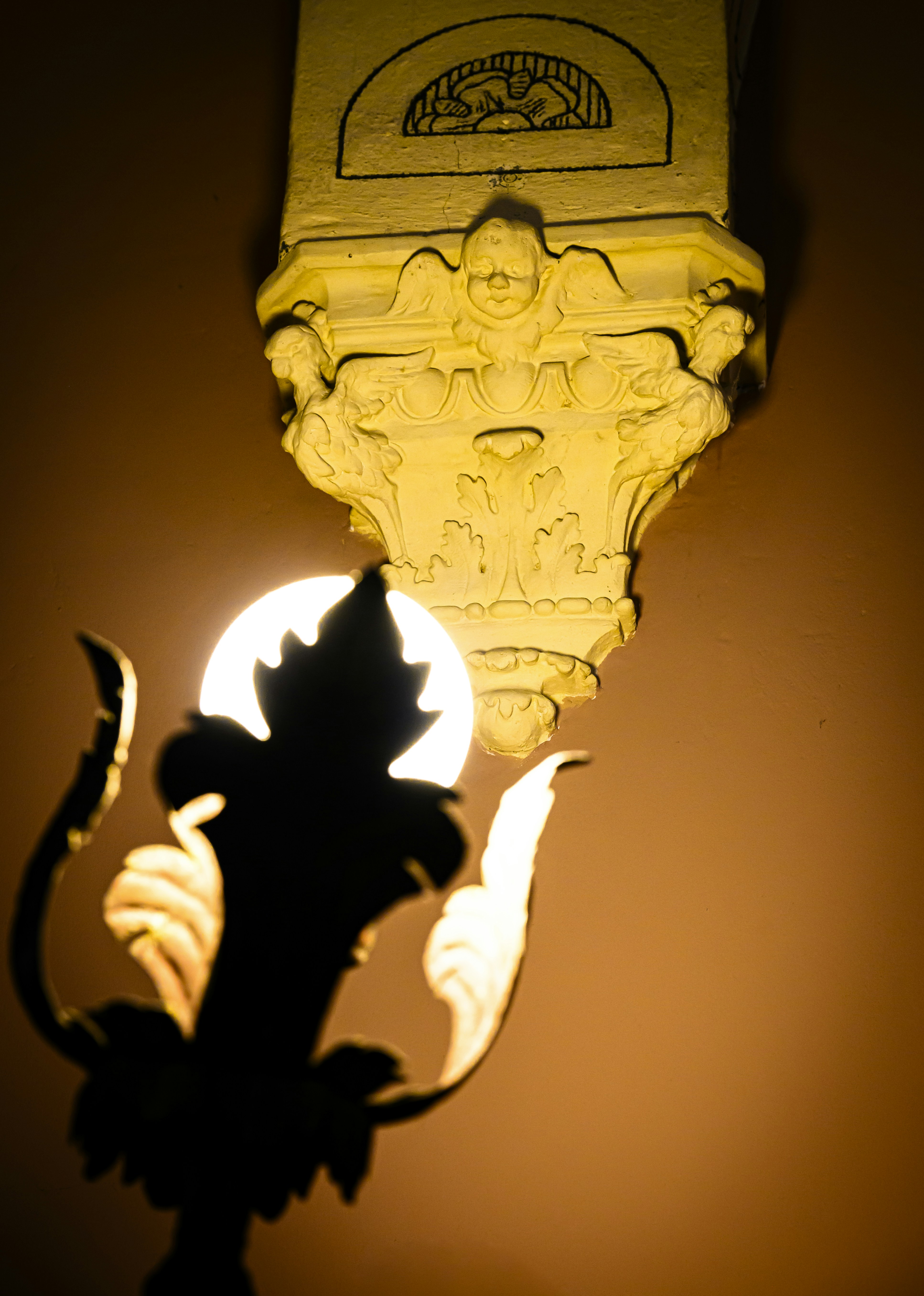 Golden Glow: Silhouette and Carved Arch in Night Quiet