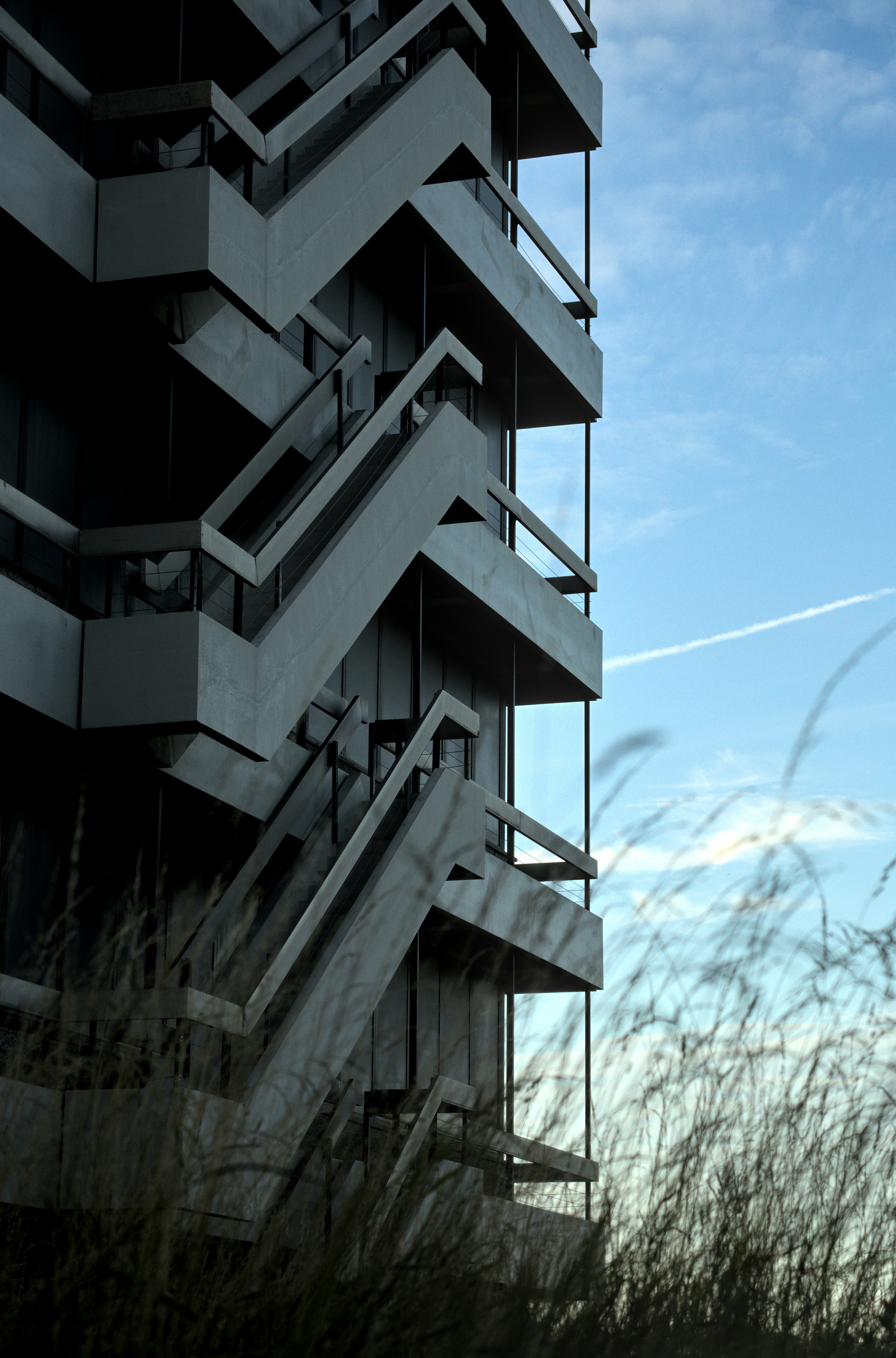 Angular Rhythm: Zigzag Balconies Stacking Against a Blue Sky