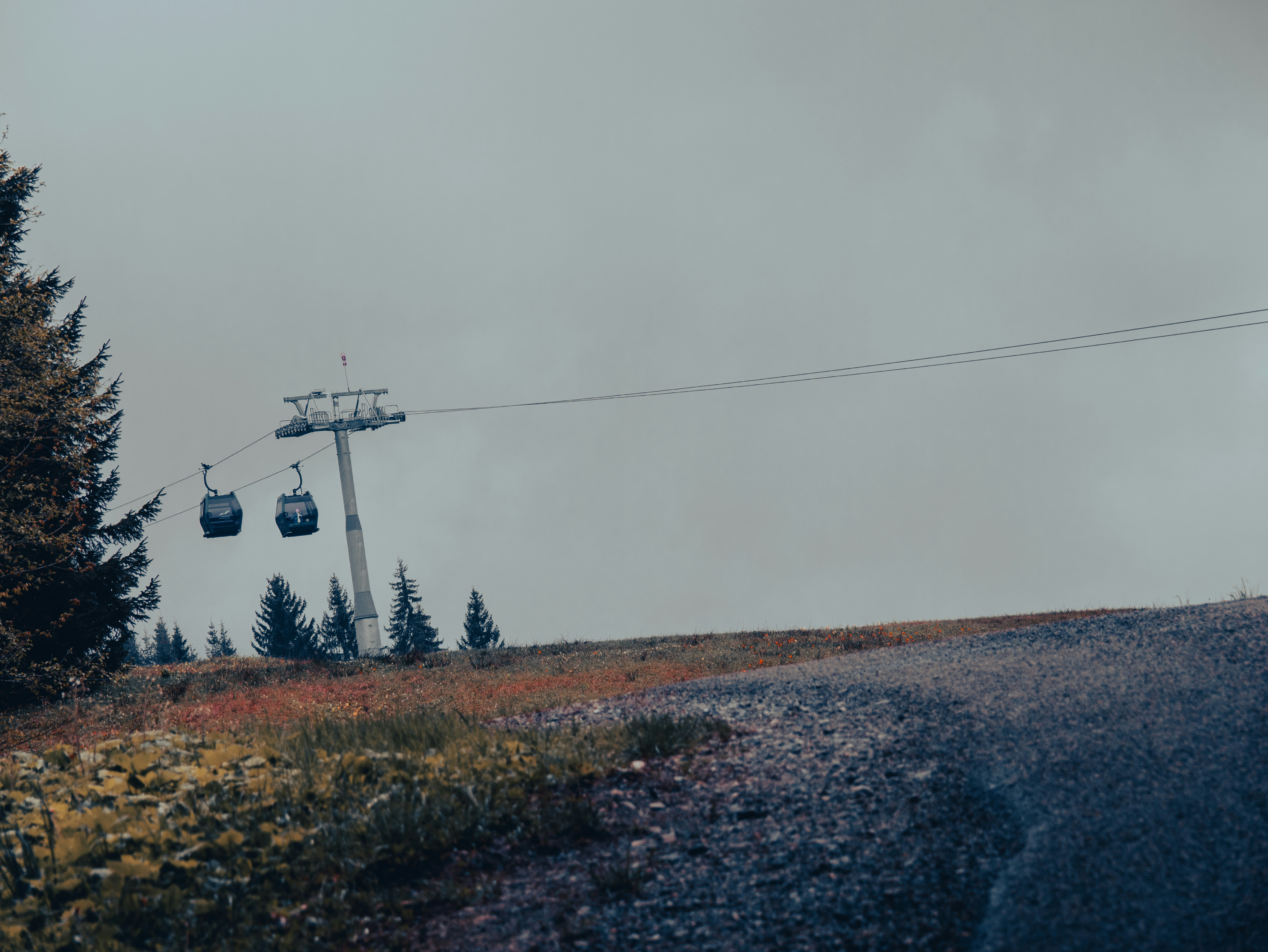 Mist-Wreathed Gondola Over a Rugged Alpine Ridge