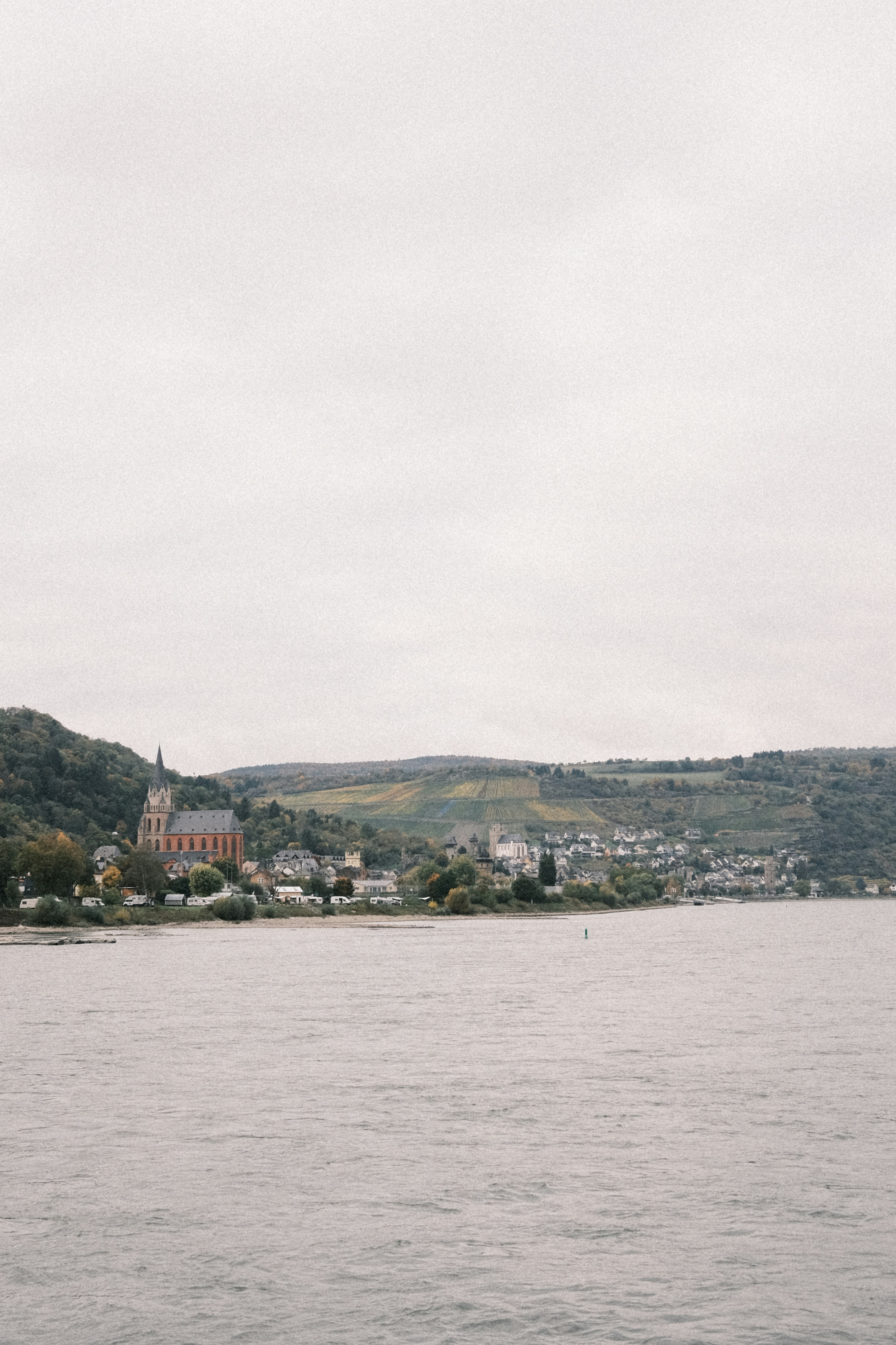 Spire by the Lake: A Quiet Lakeside Town Framed by Gentle Hills