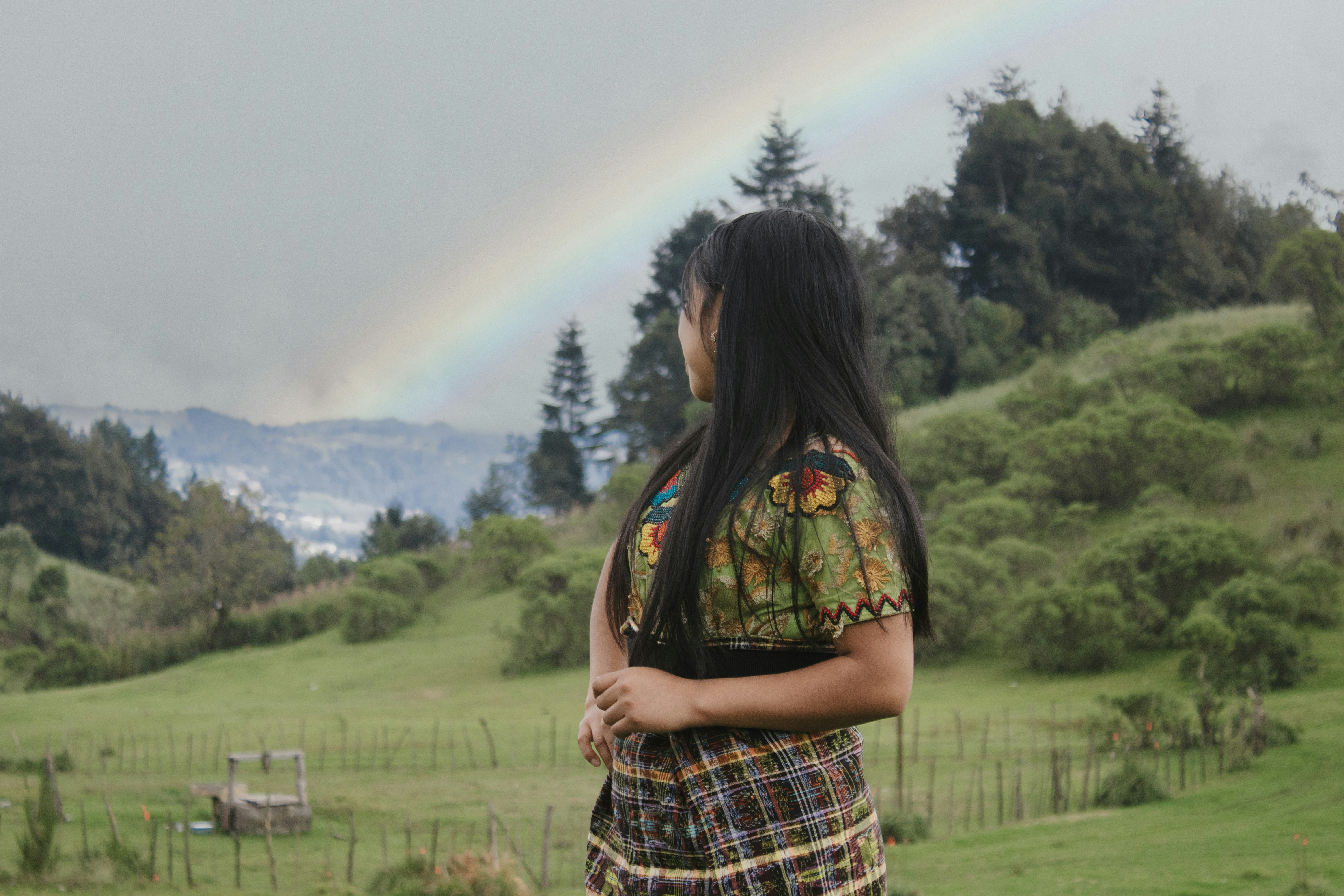 Rainbow Over the Hills: Portrait in a Green Landscape