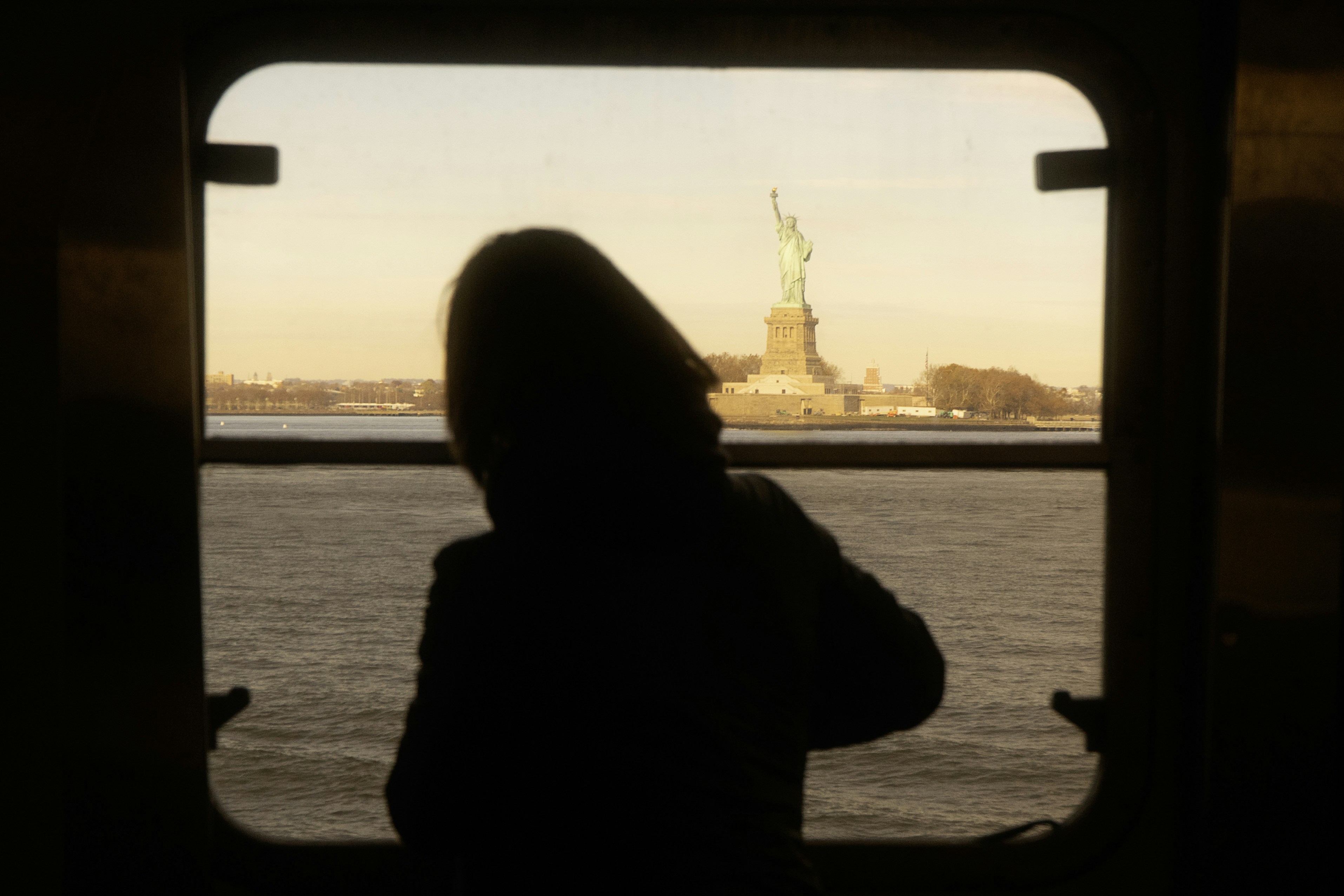 Photo of tourist taking a photo of the Statue of Liberty on the Staten Island Ferry