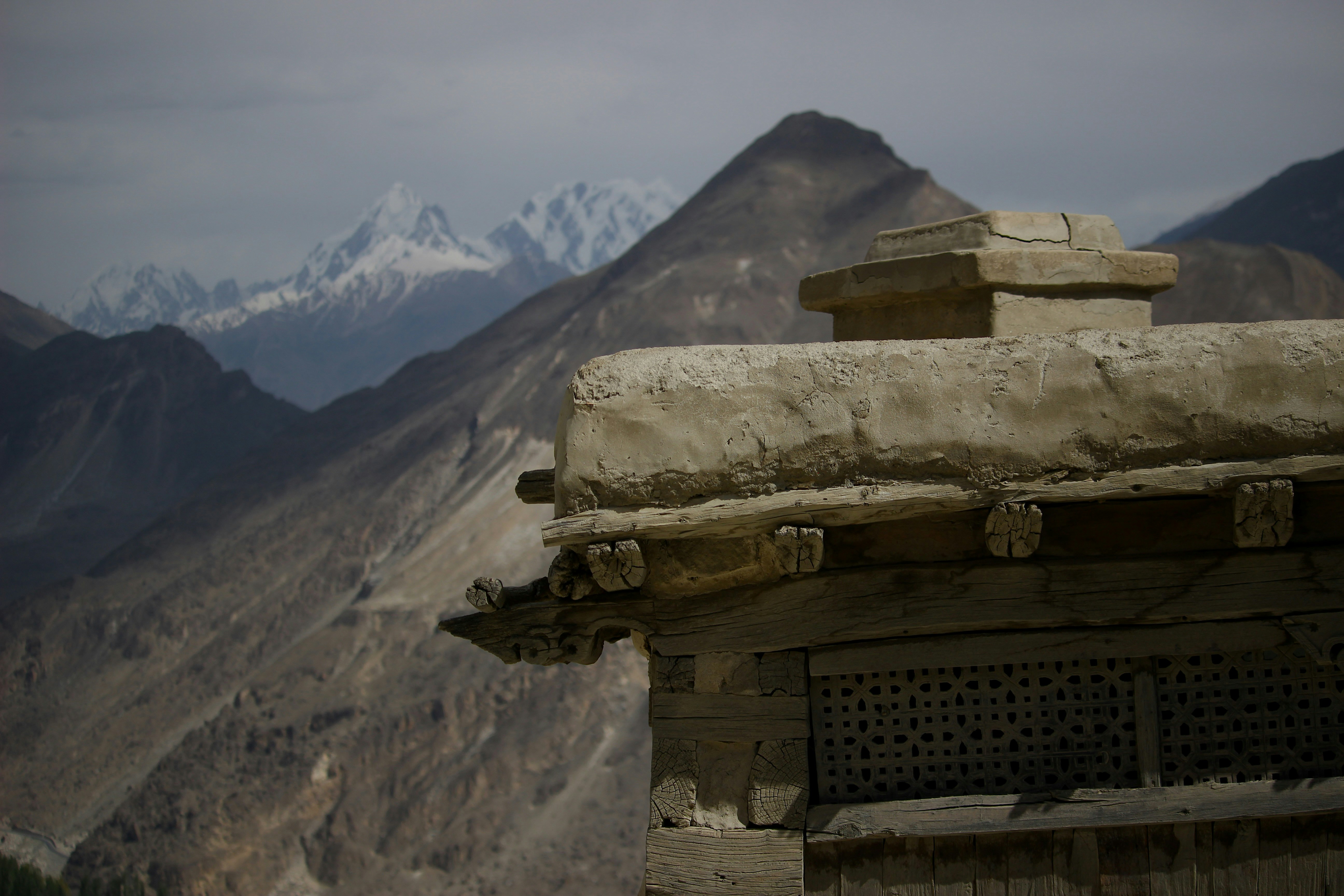 Weathered Terrace Shrine Framed by Snow-Crowned Peaks