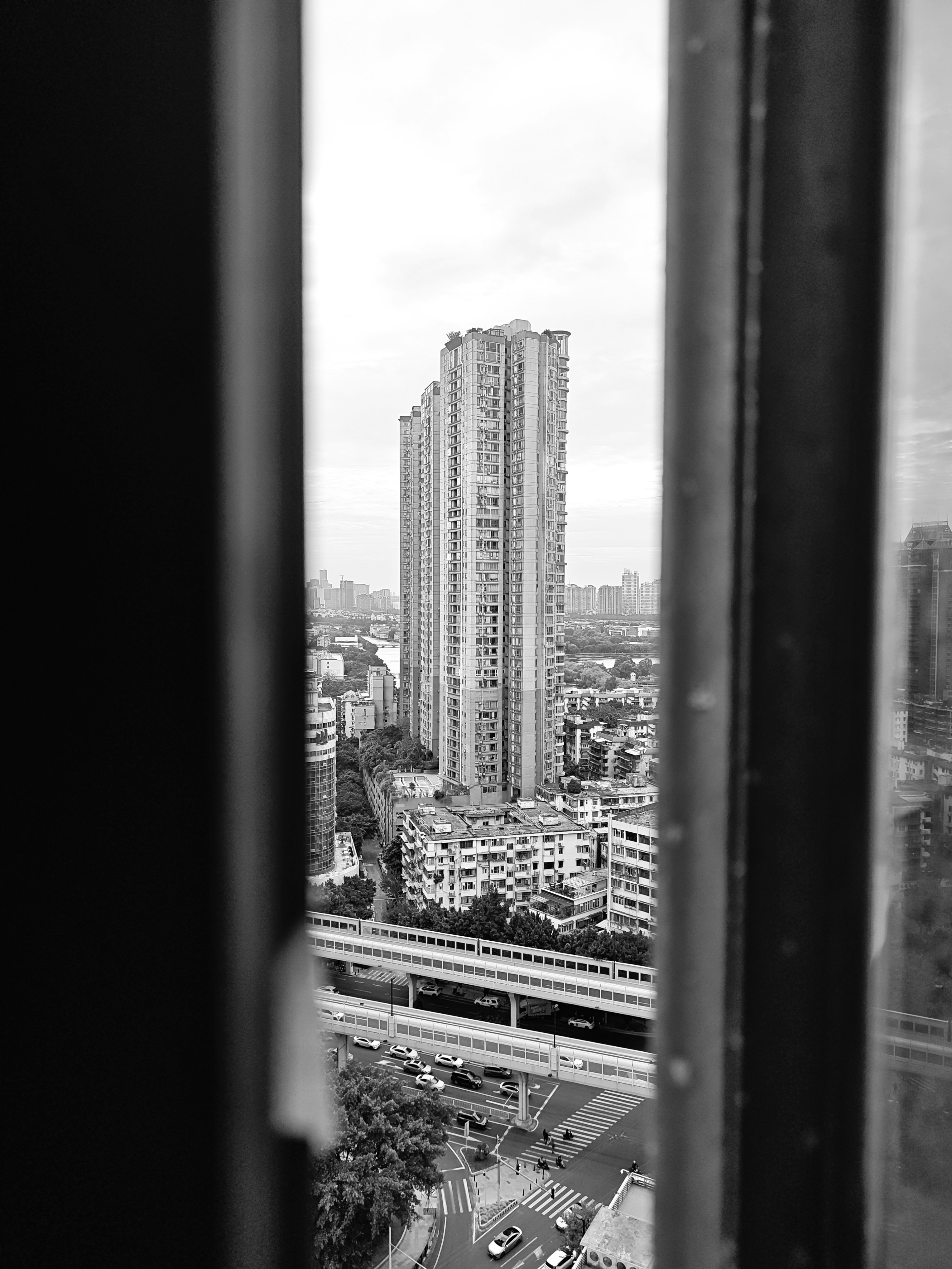 View of a cityscape with tall buildings through a window. photo – Free ...