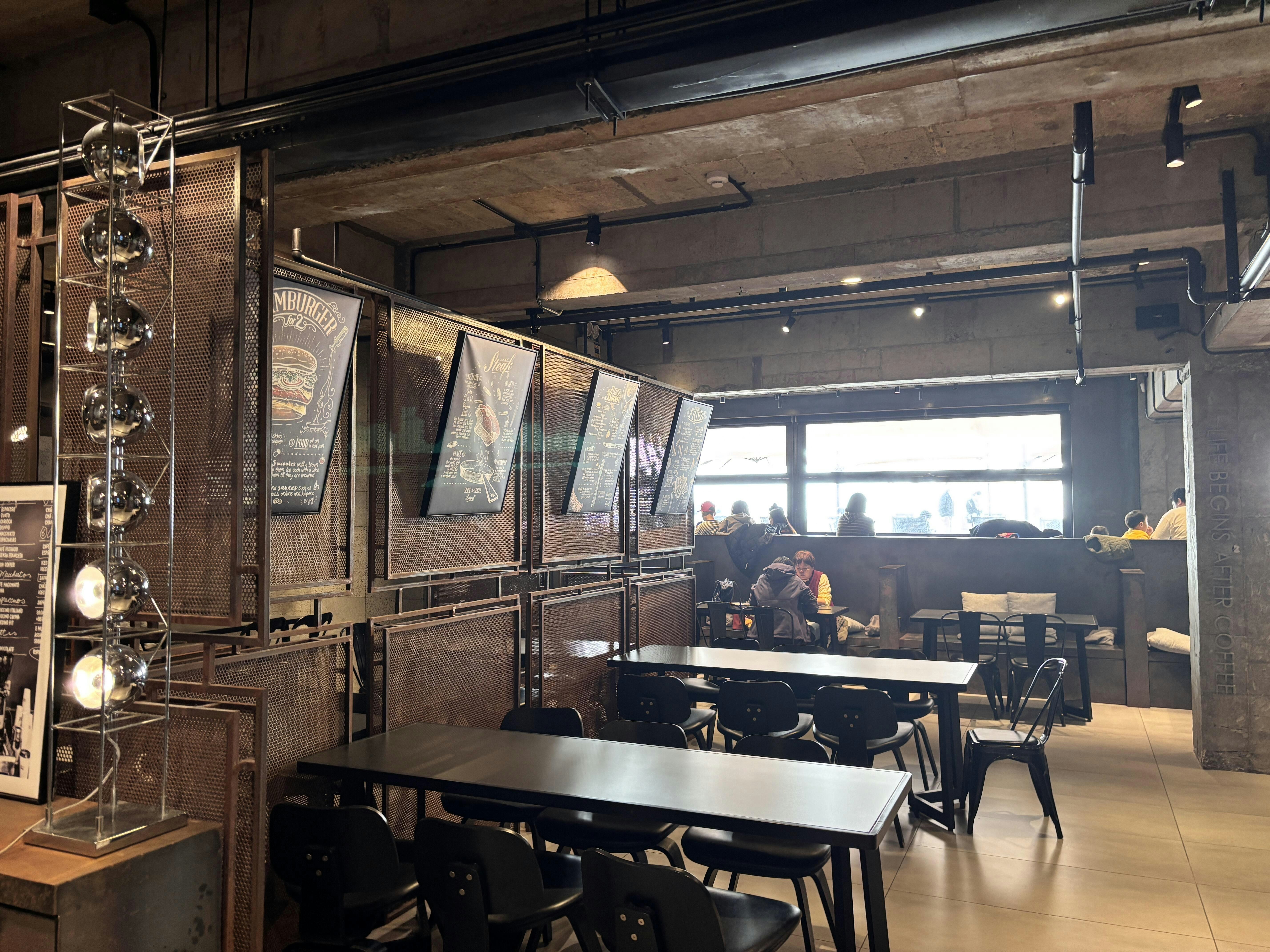 Interior of a modern coffee shop with tables and chairs.