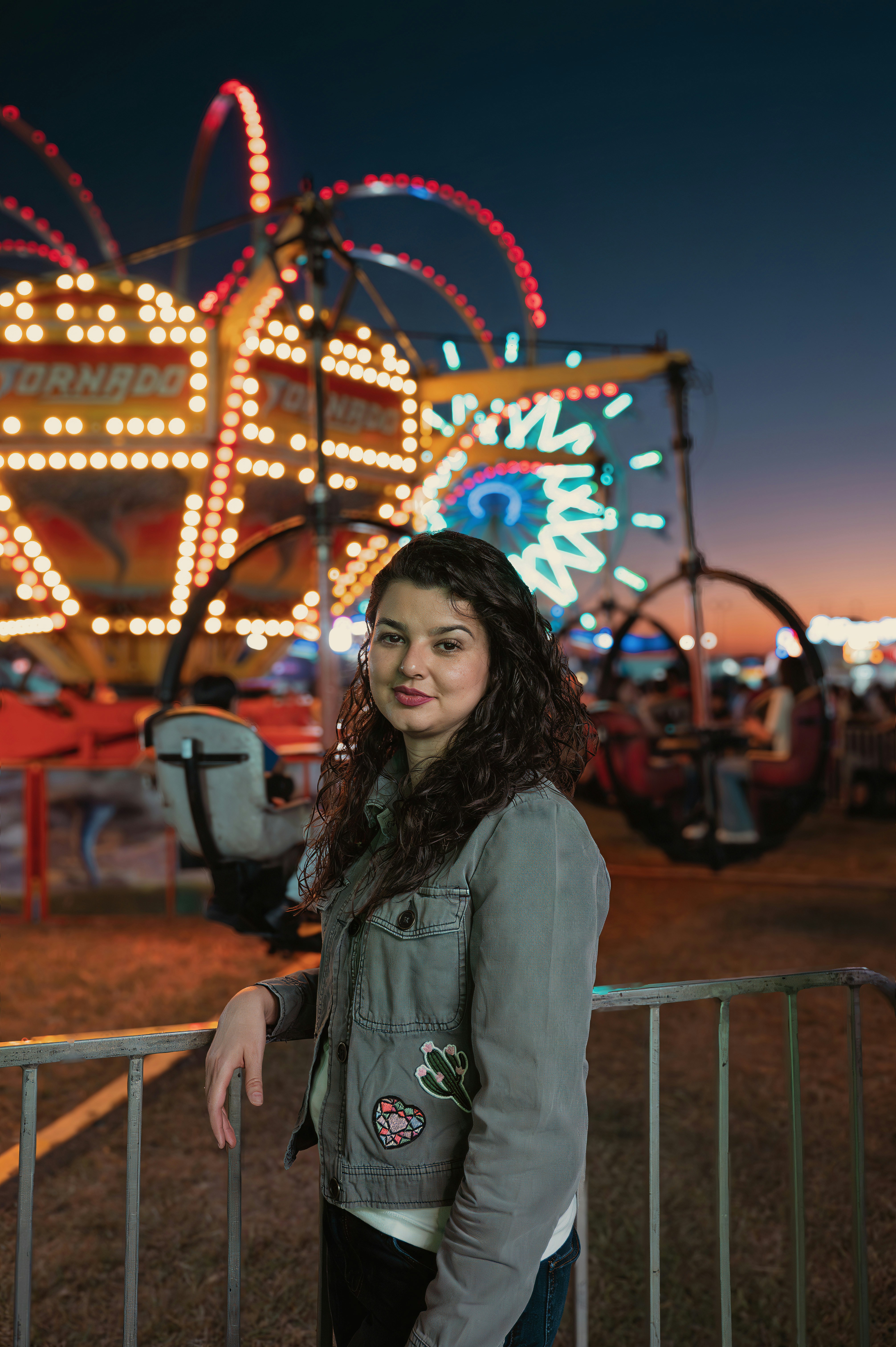 Neon Whirl Portrait: A Quiet Moment Amid Carnival Lights
