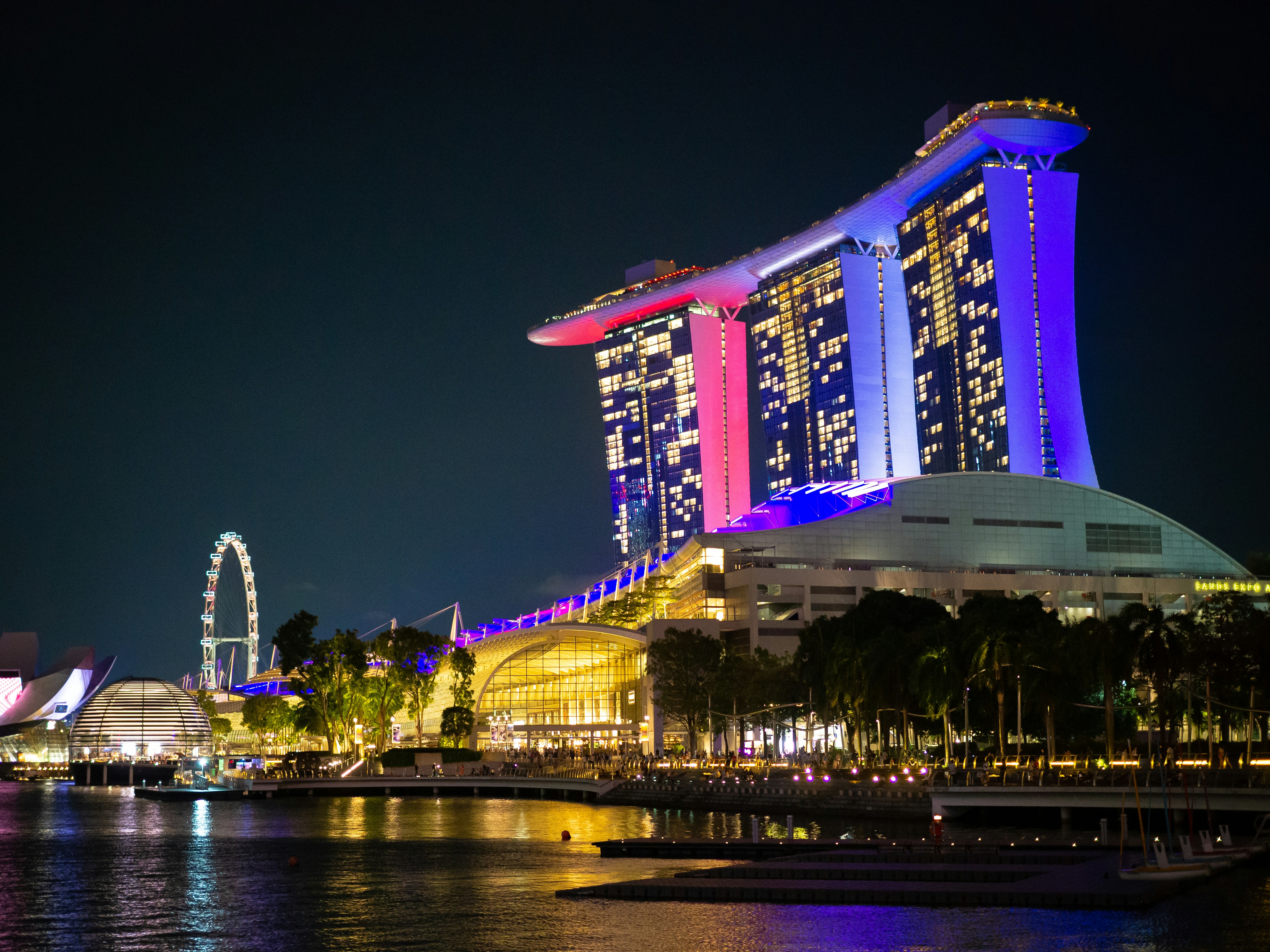 Tri-Tower Nightscape: Marina Bay Sands Illuminated in Neon Blues, Pinks, and Purples