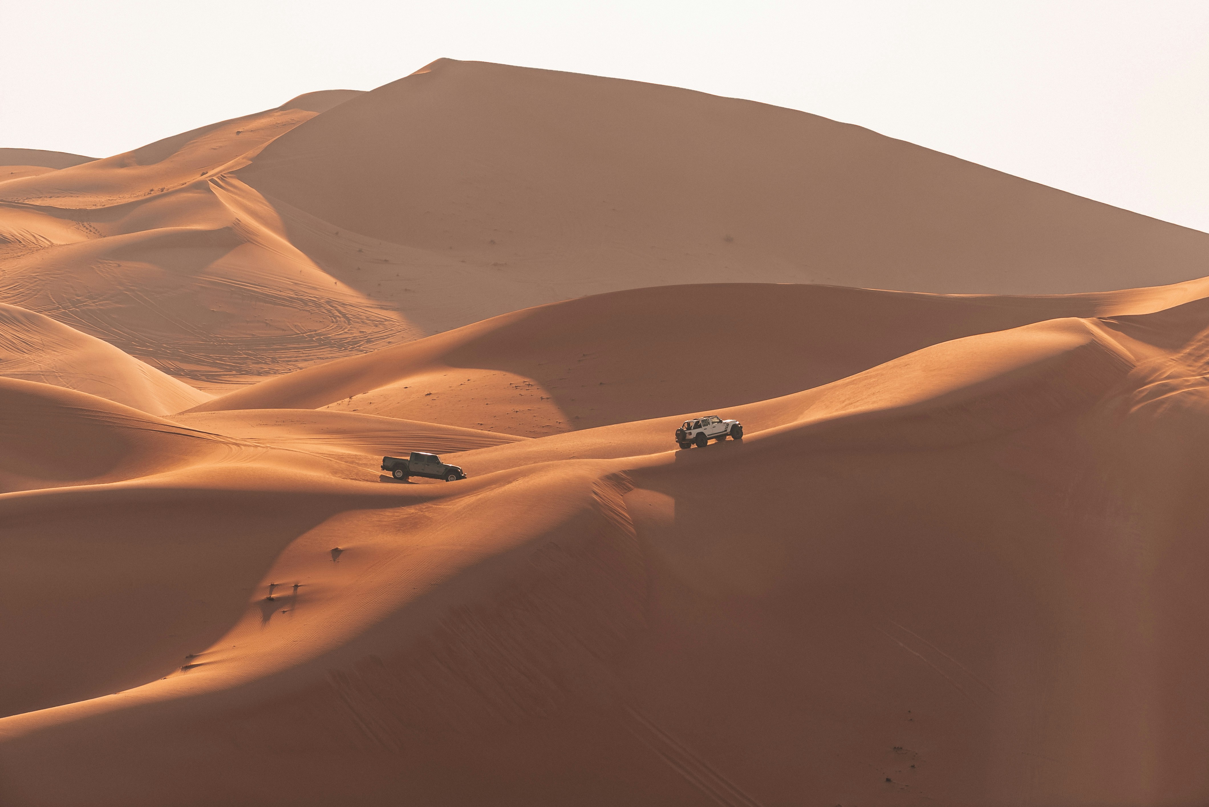 Two vehicles driving on sand dunes at sunset photo – Free Travel Image ...