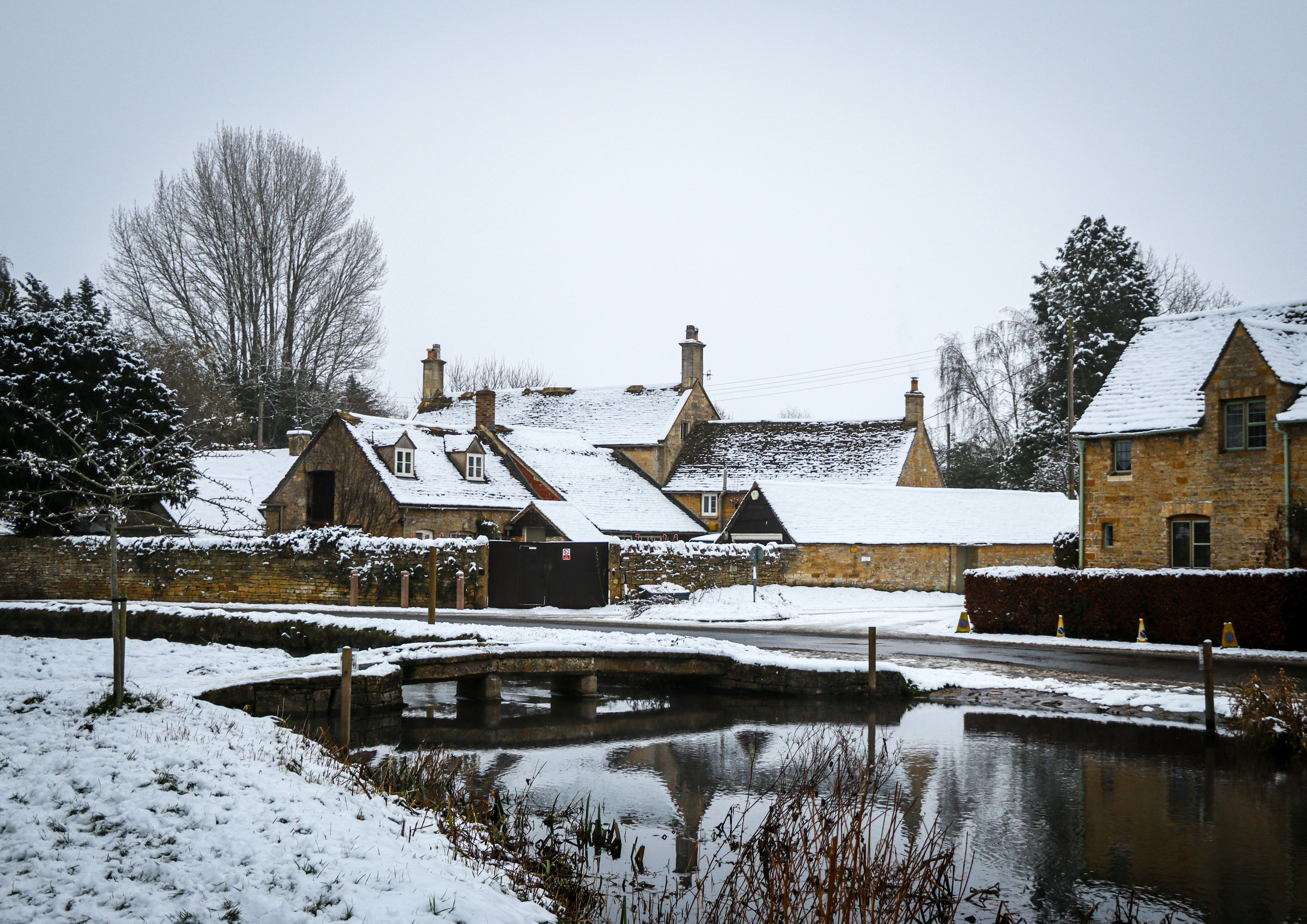 Winter's Mirror: Snowbound Stone Village and Its Quiet Pond
