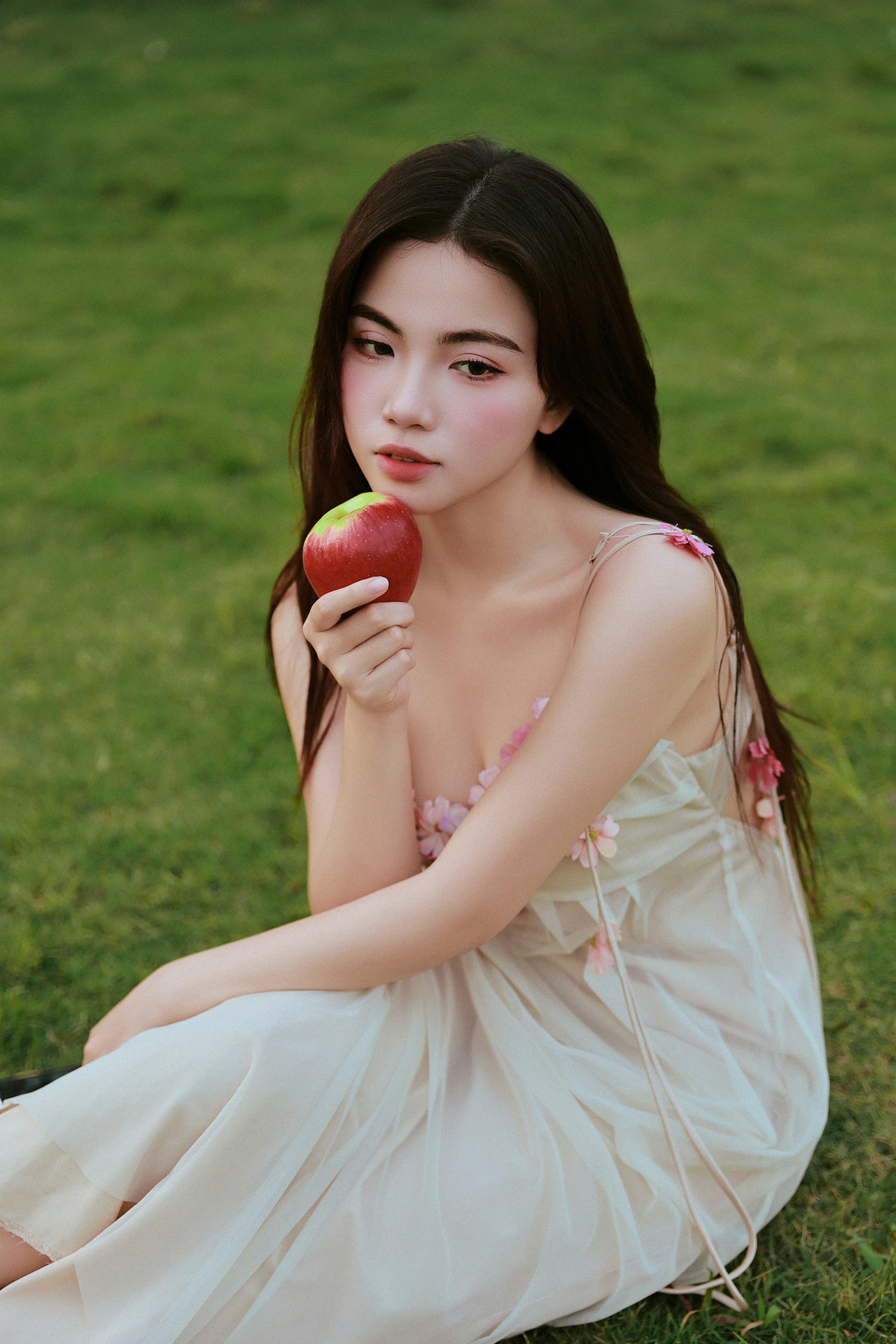 Young woman in a floral dress during golden hour.