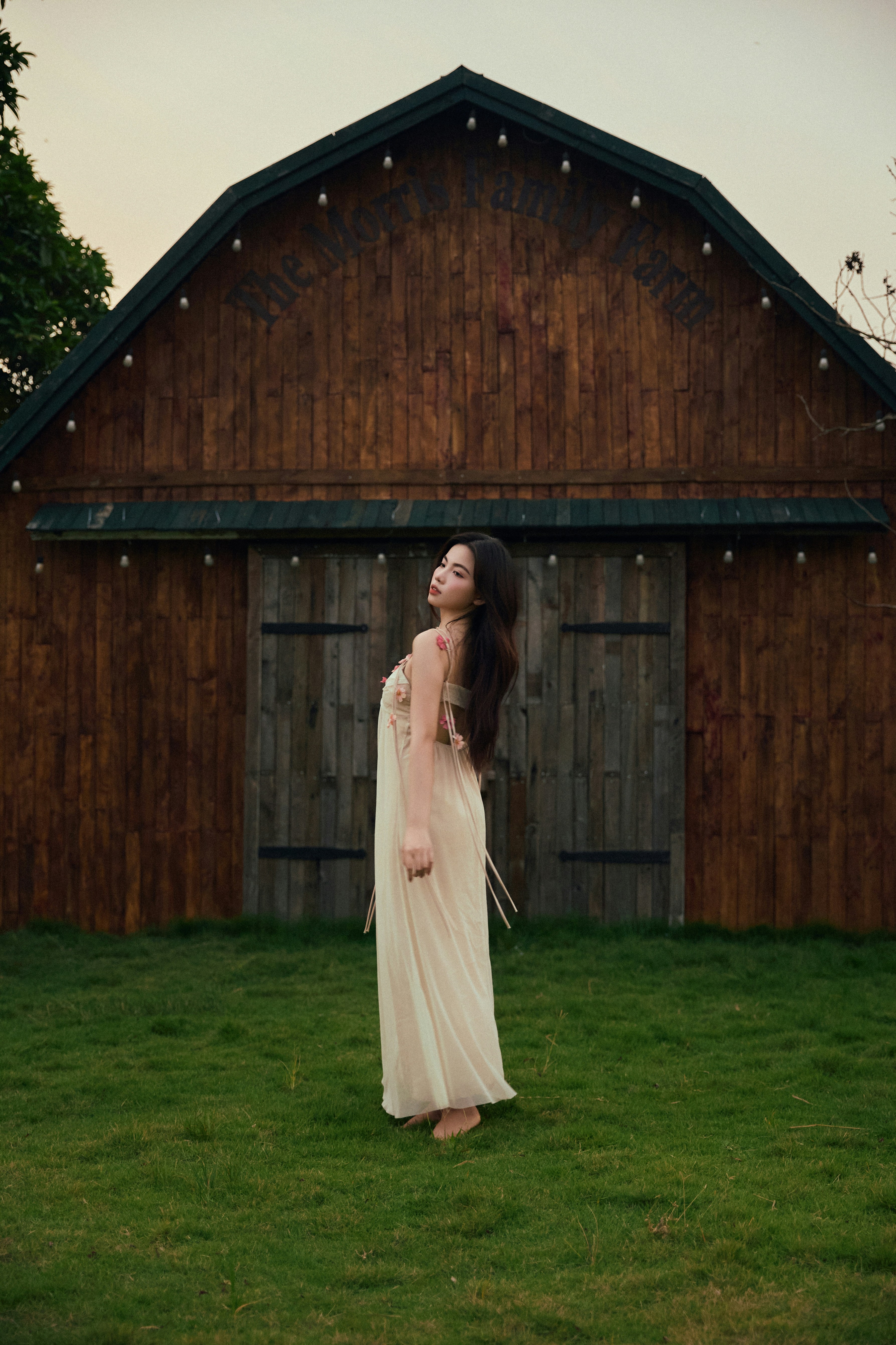 Young woman in a floral dress during golden hour.