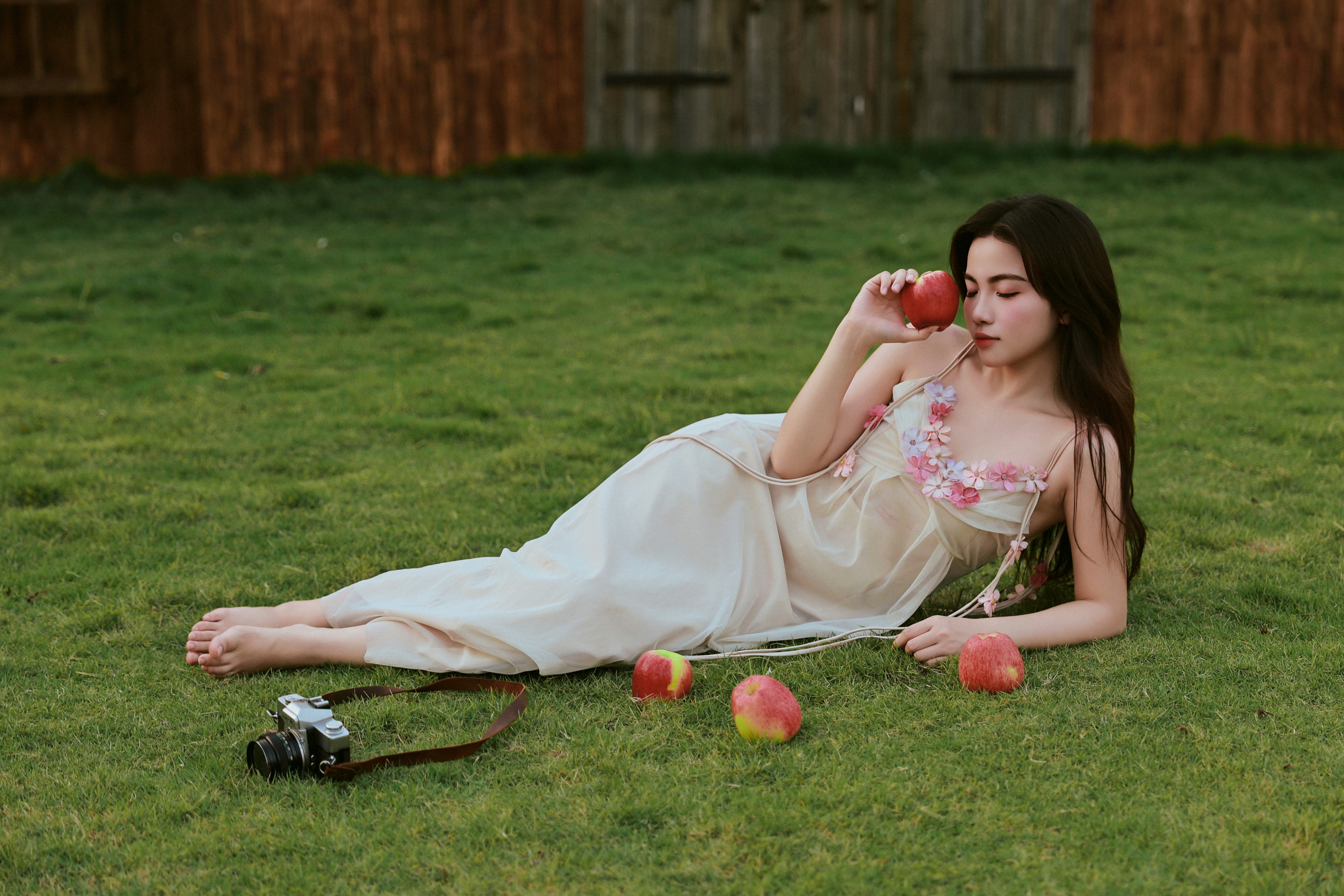 Young woman in a floral dress during golden hour.